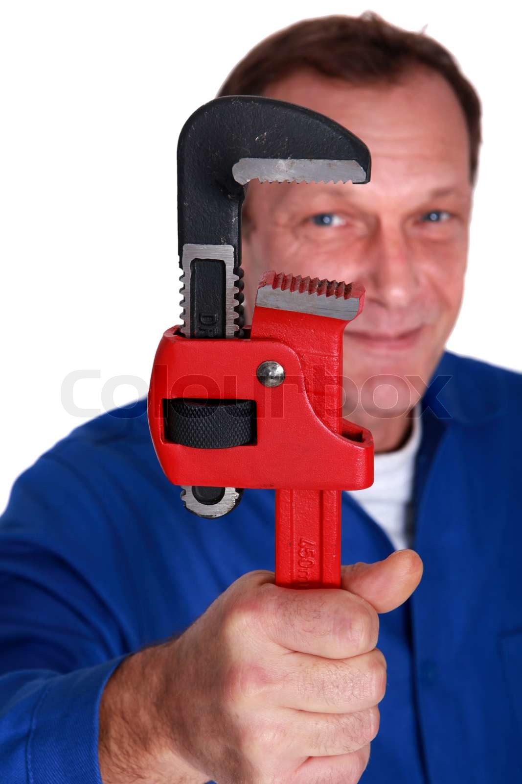 Plumber holding large tool | Stock image | Colourbox