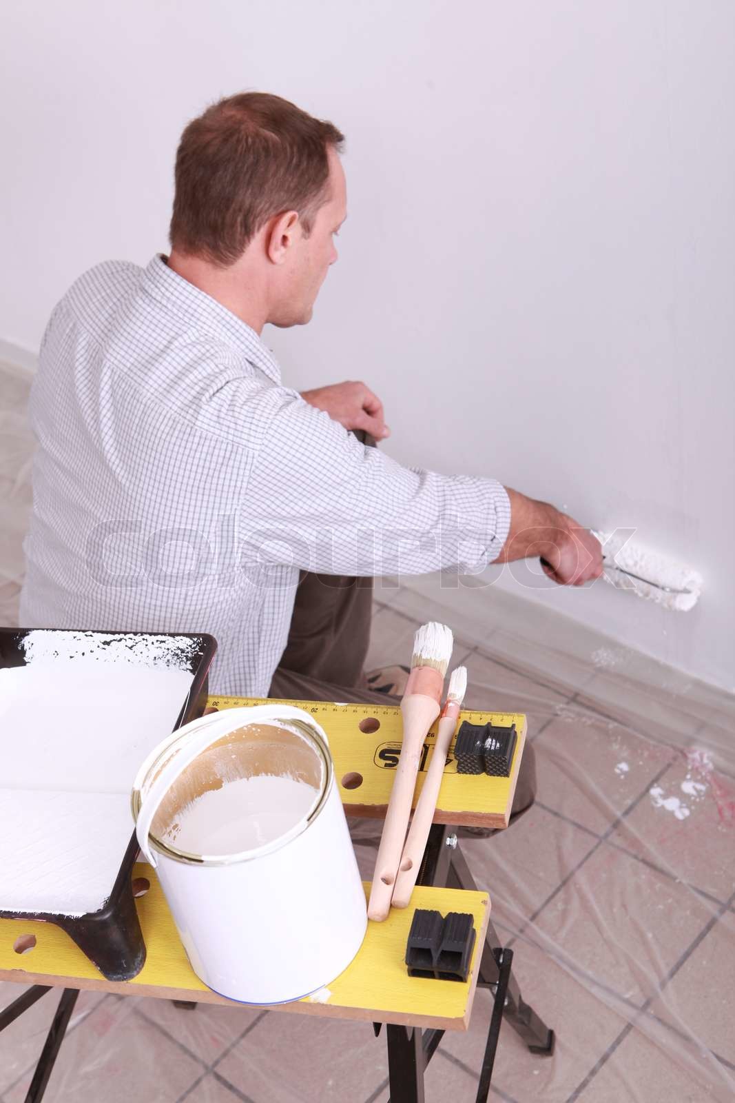 Painter using roller | Stock image | Colourbox