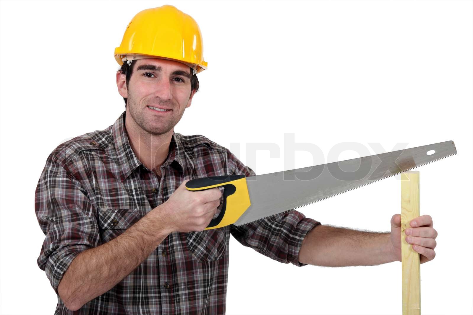 Man sawing plank of wood | Stock image | Colourbox