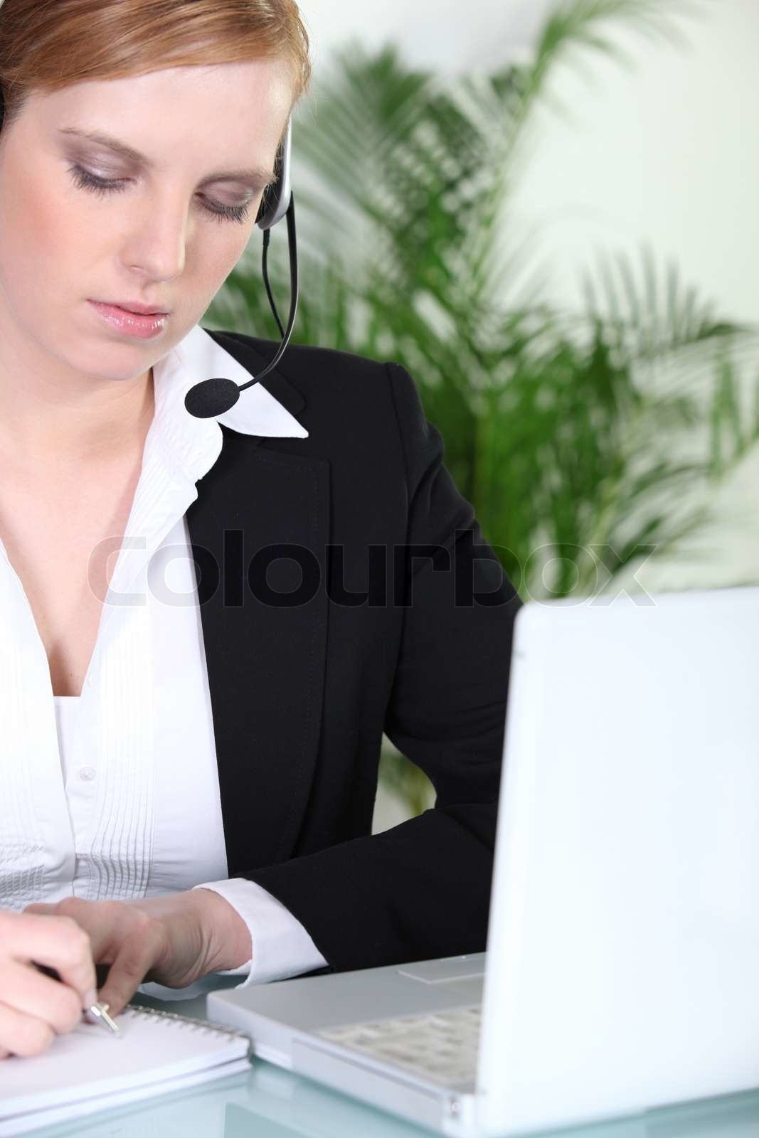 Secretary taking a message | Stock image | Colourbox