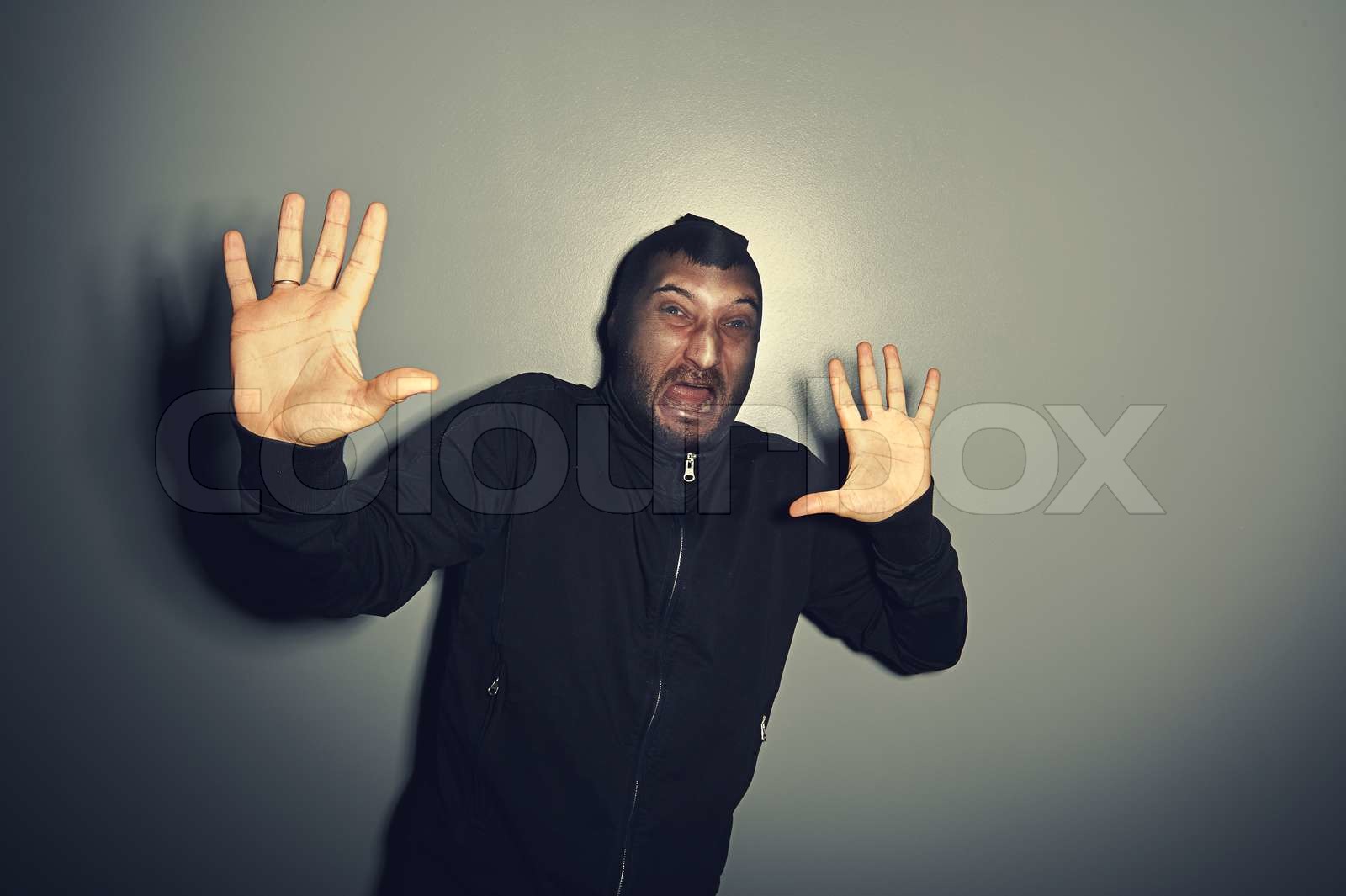 man screaming and raising hands up | Stock image | Colourbox
