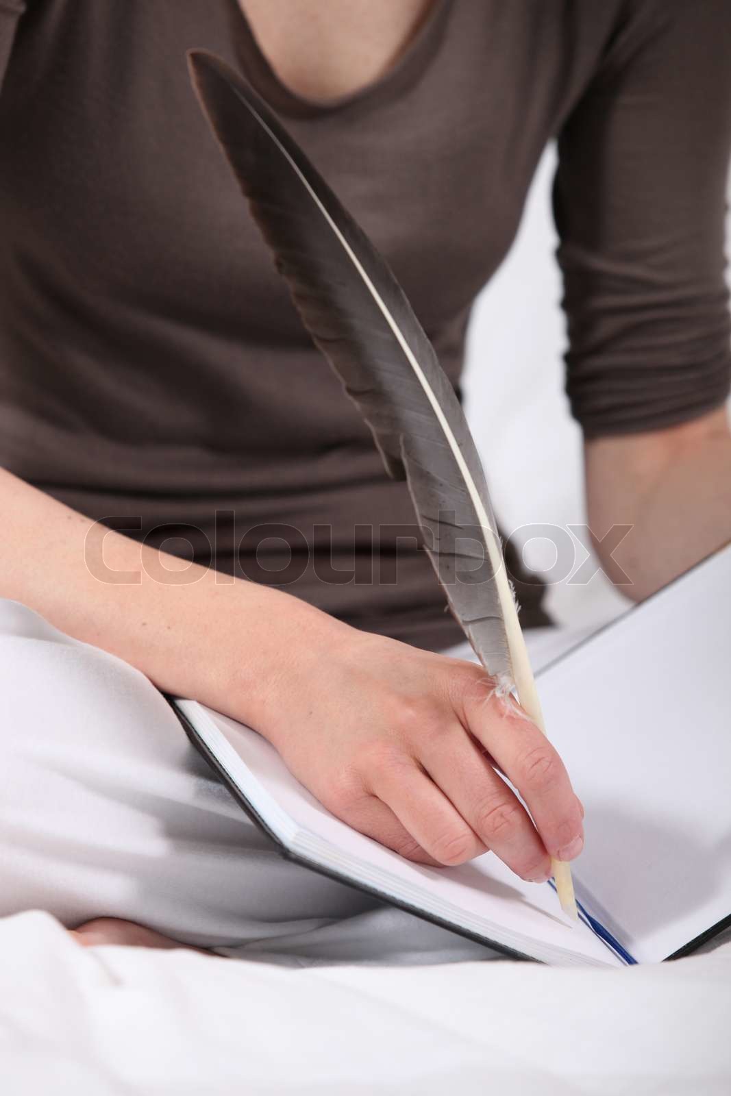 Woman writing with a feather | Stock image | Colourbox