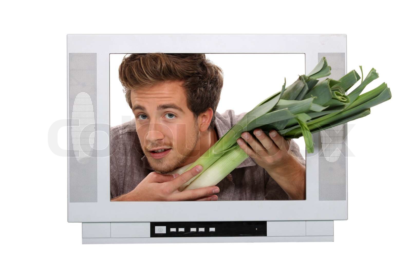 Man holding leek coming out of television | Stock image | Colourbox
