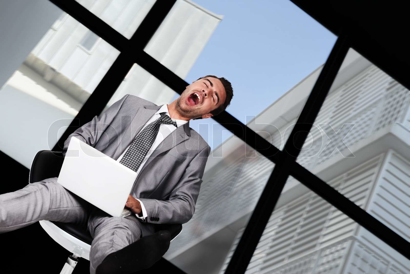 Businessman laughing hysterically | Stock image | Colourbox