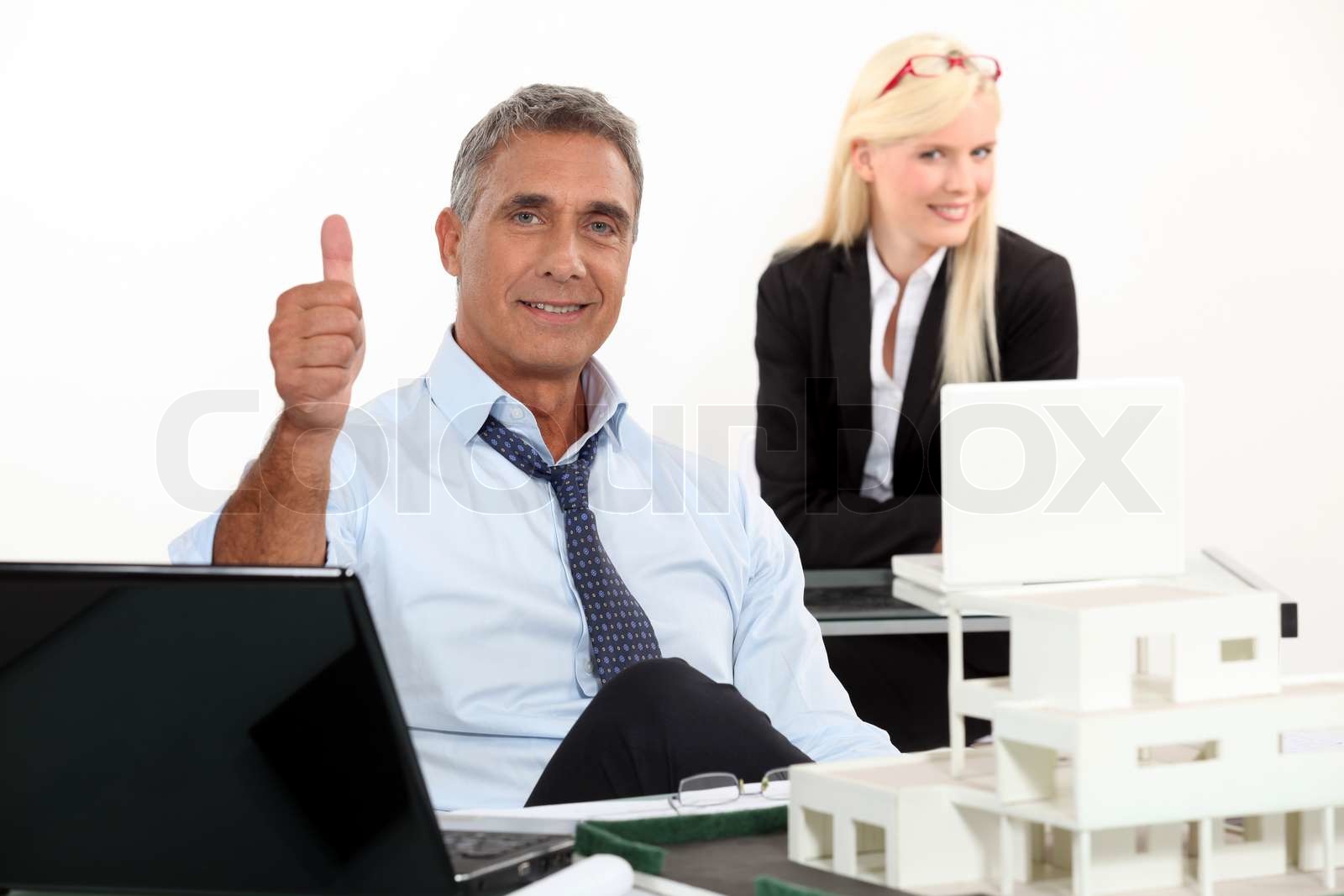 Estate agent with thumbs up | Stock image | Colourbox