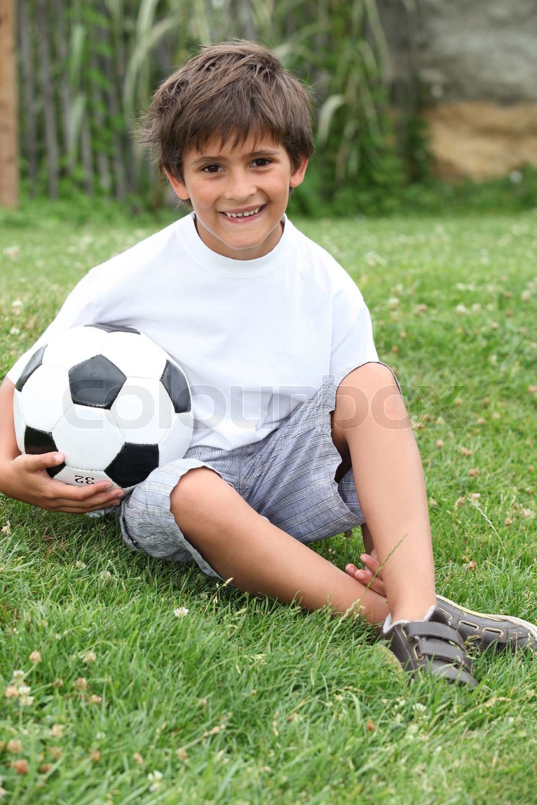 Little boy with a football | Stock image | Colourbox