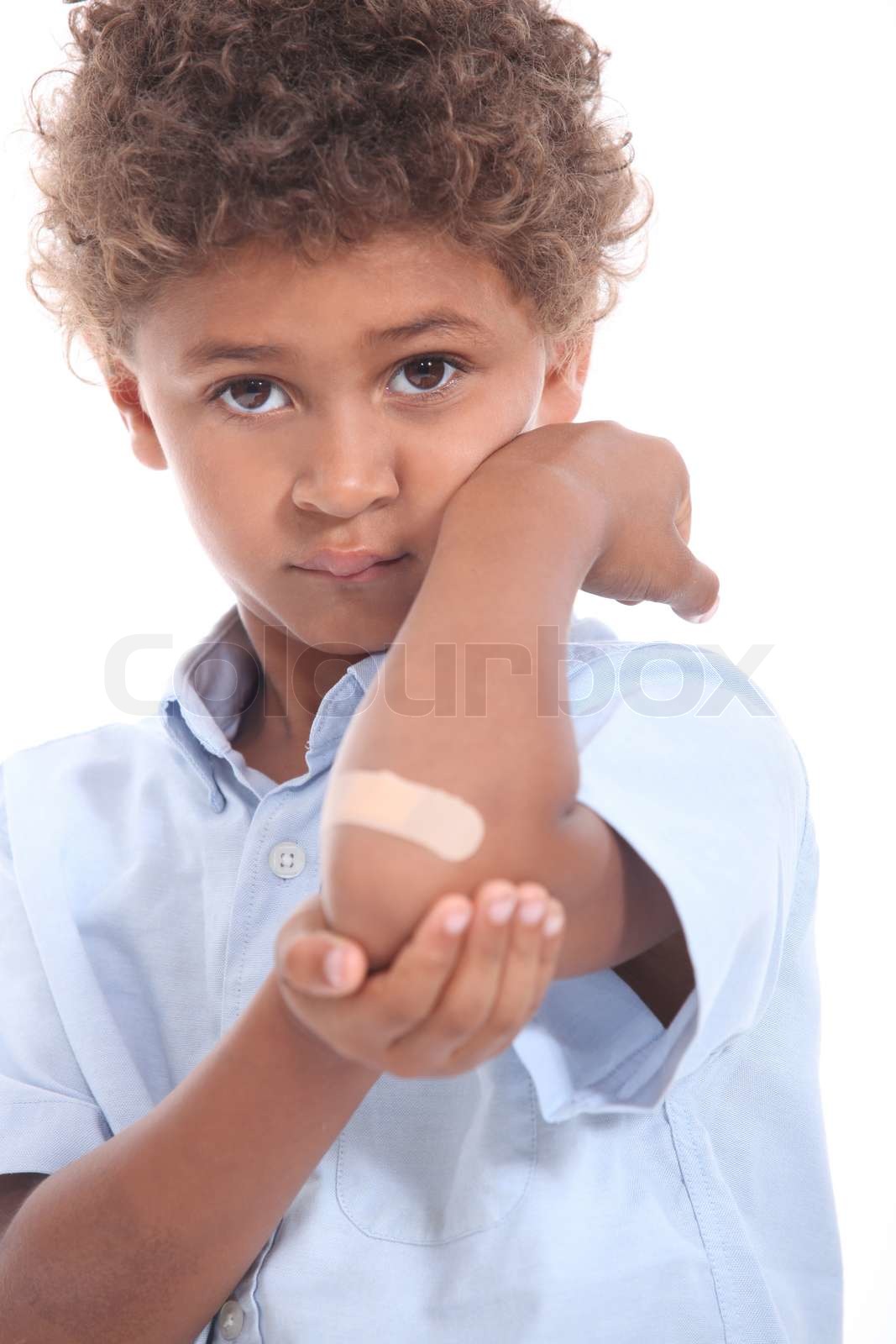 Little boy with a plaster on his arm | Stock image | Colourbox