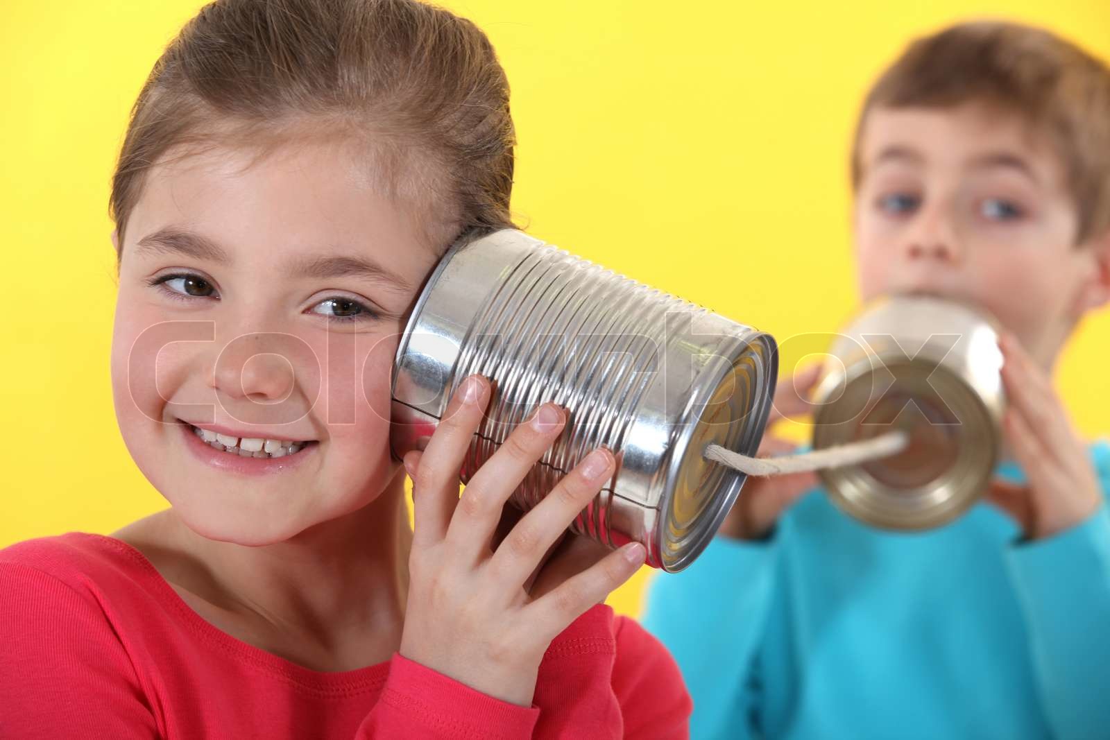 Kids using tin cans to communicate | Stock image | Colourbox