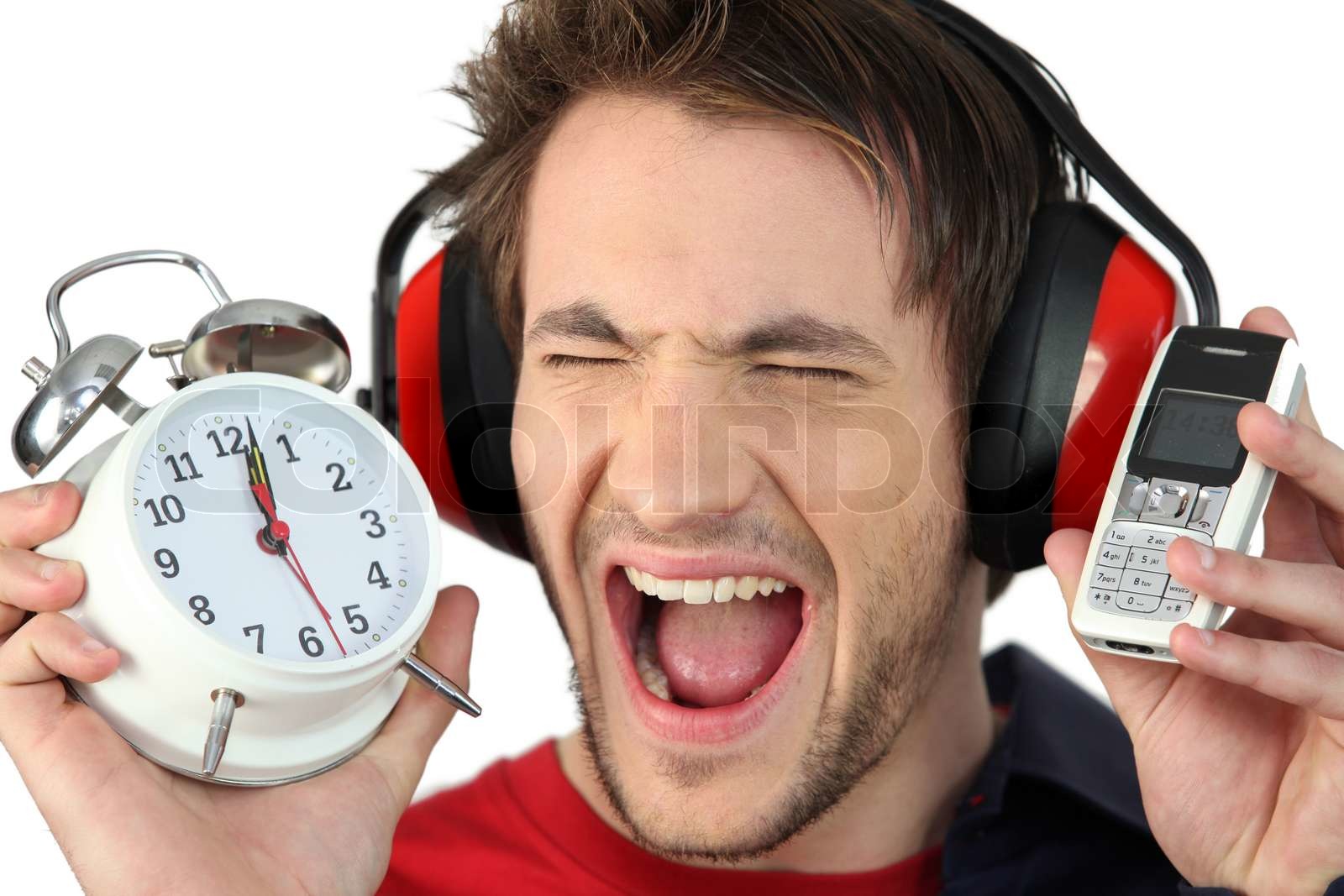 Man screaming at his alarm clock | Stock image | Colourbox