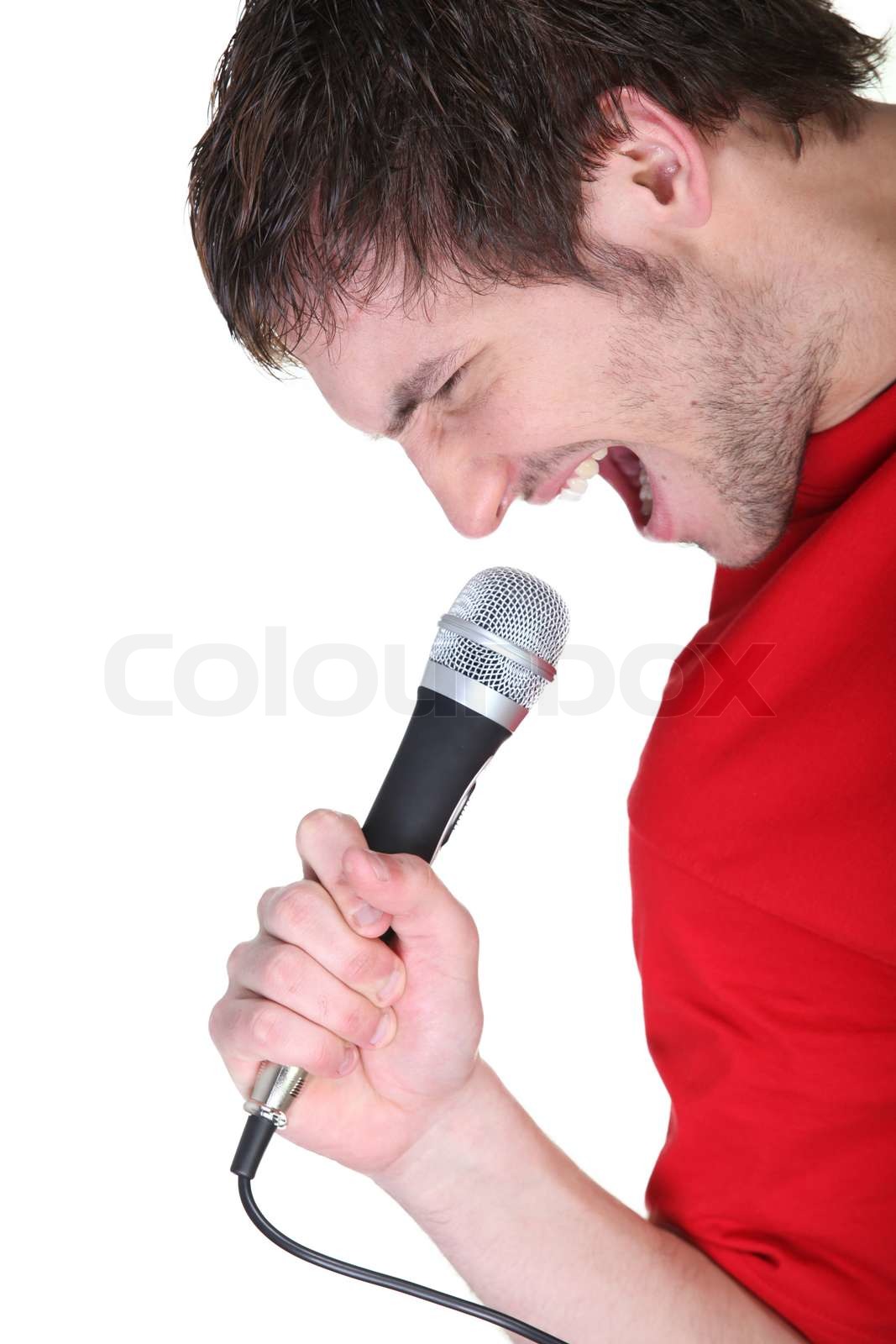 Man singing into microphone | Stock image | Colourbox