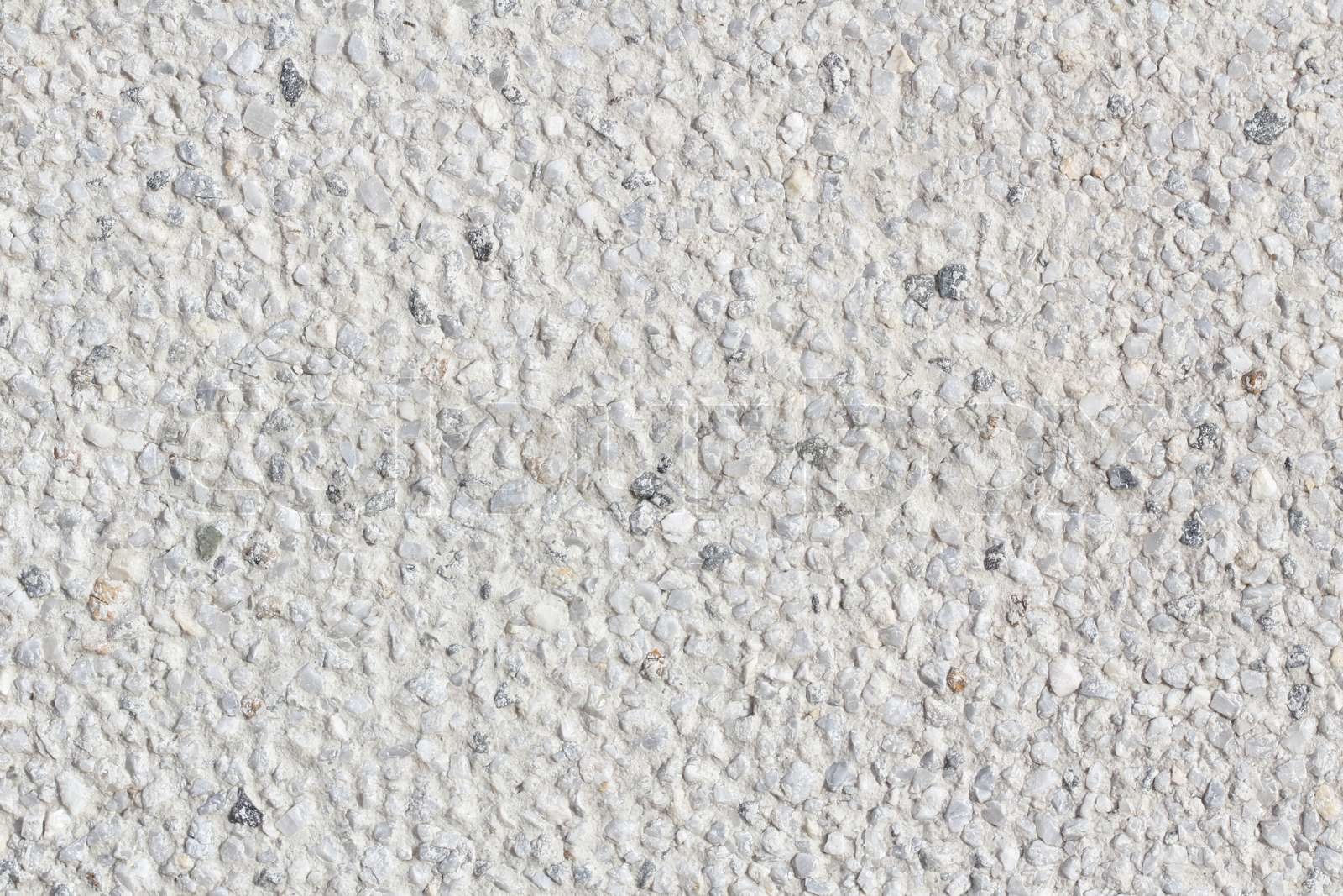 Abstract background paving consisting of small pebbles embedded in ...