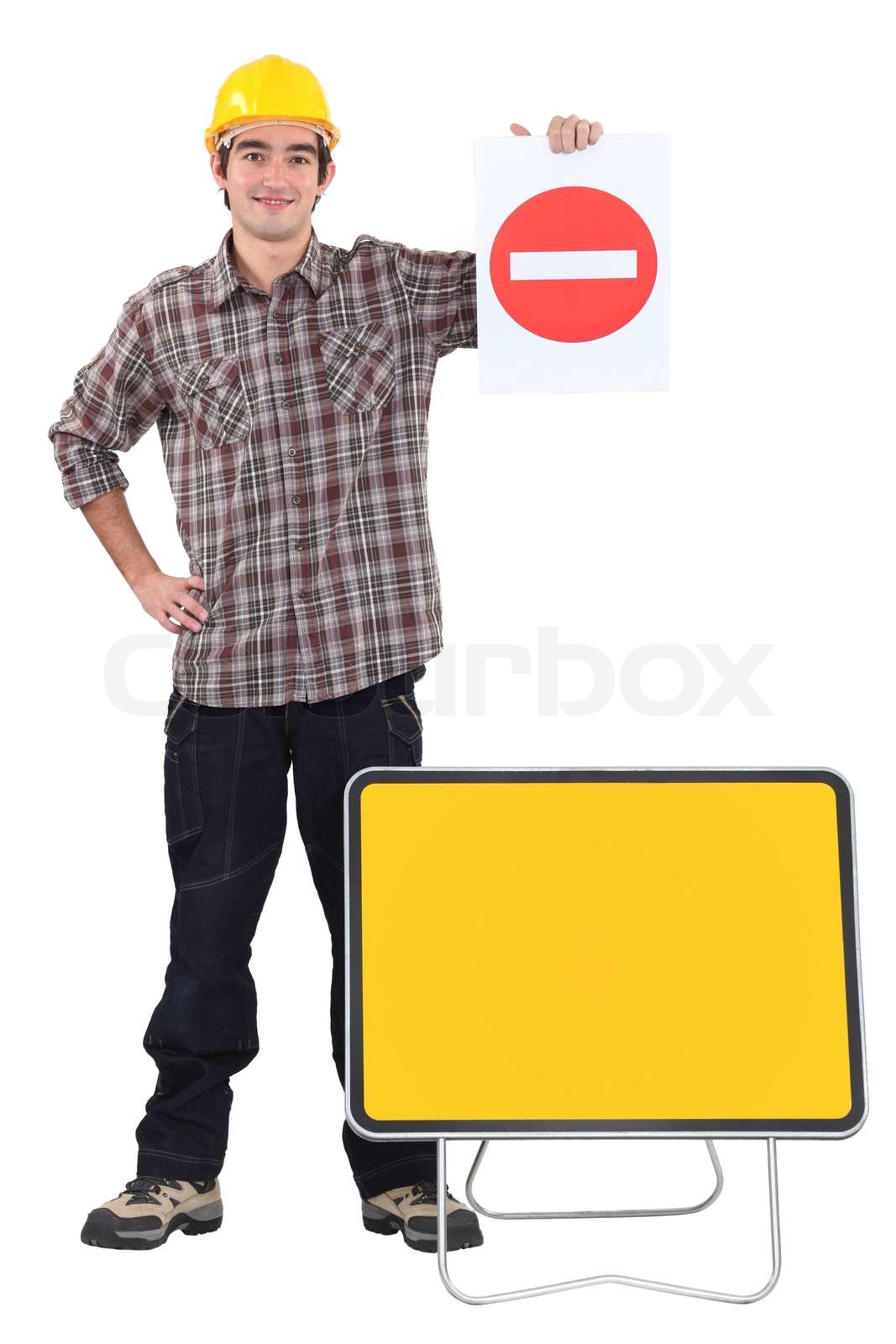 Traffic worker stood with road signs | Stock image | Colourbox