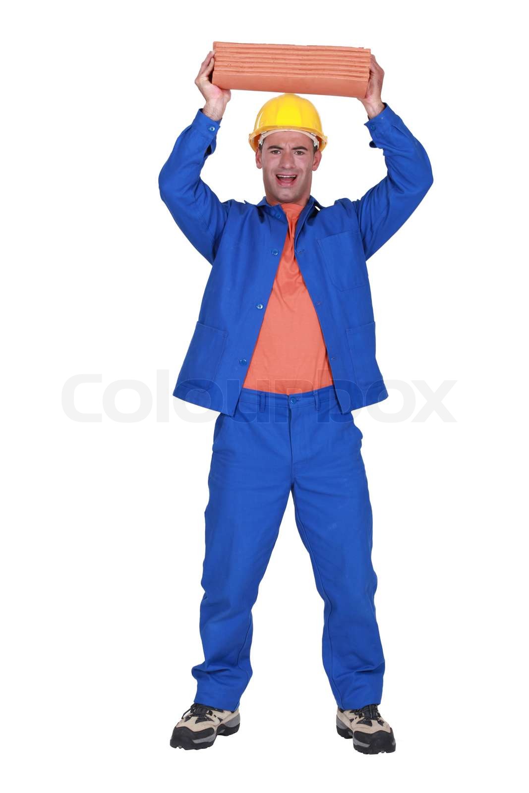 Man lifting large brick over head | Stock image | Colourbox