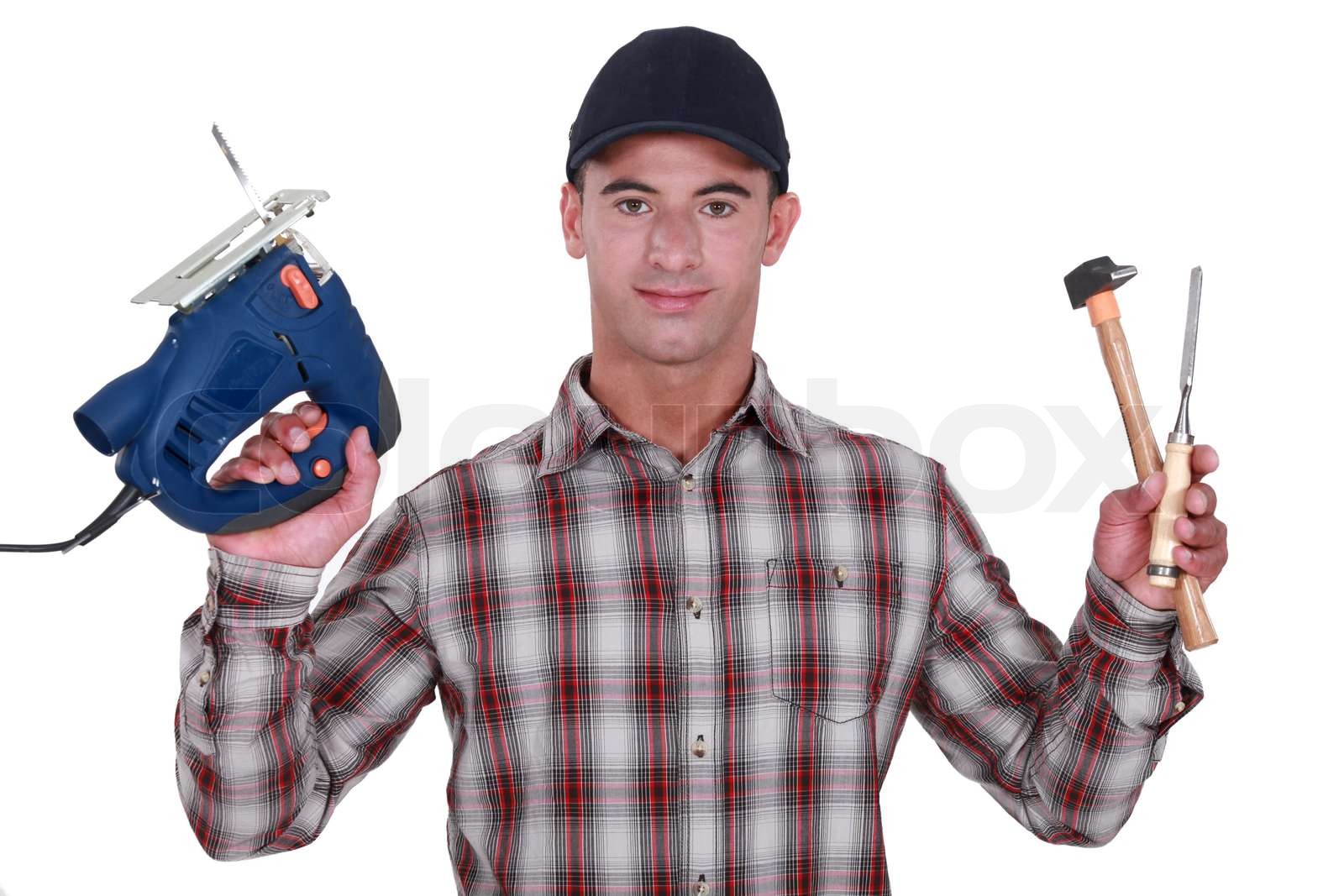 Man holder band - sav, hammer og mejsel | Stock foto | Colourbox