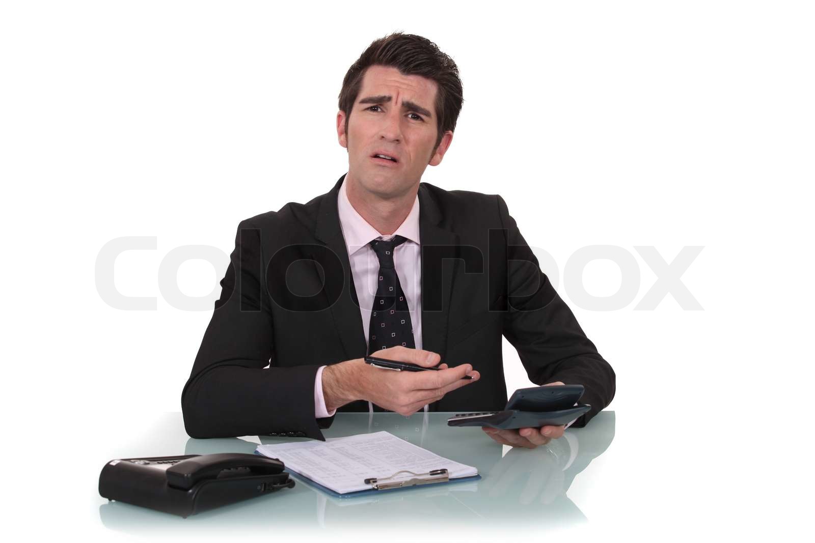 Confused businessman with a calculator | Stock image | Colourbox