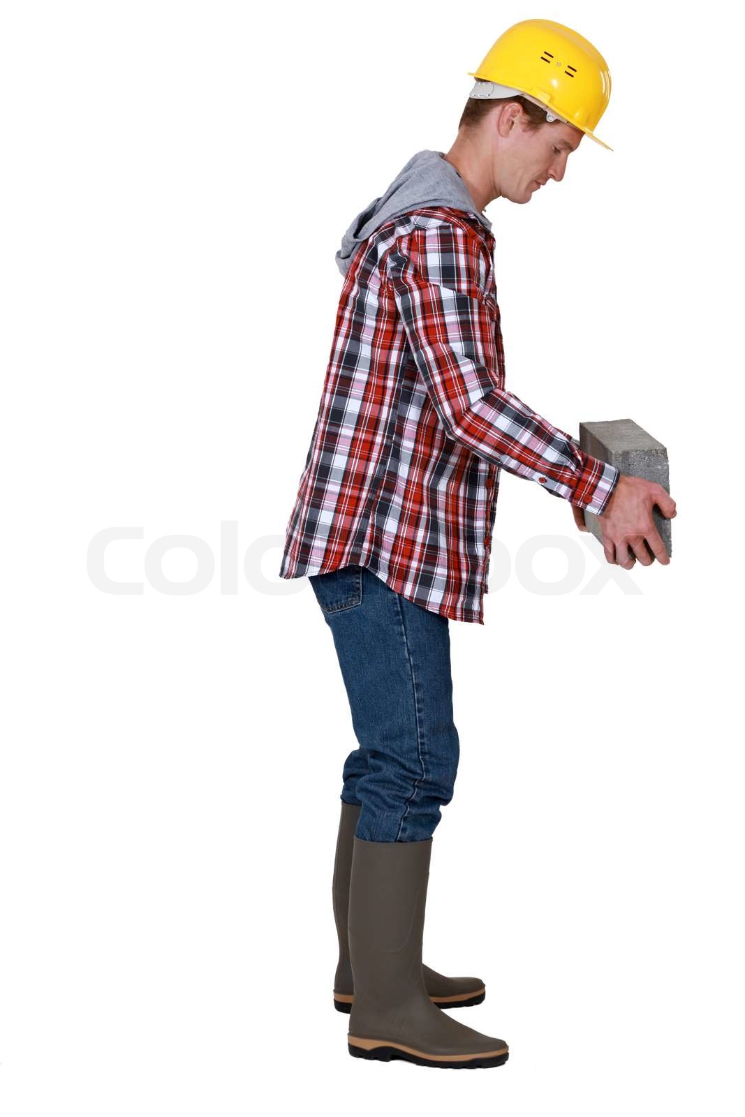 Mason lifting brick | Stock image | Colourbox