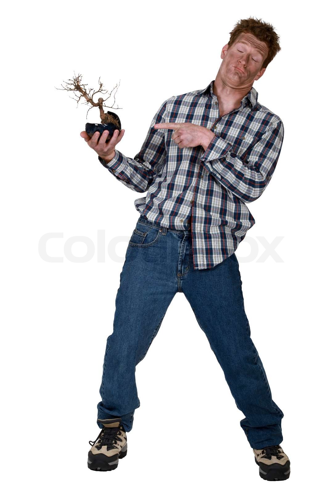 Man pointing to burnt tree | Stock image | Colourbox