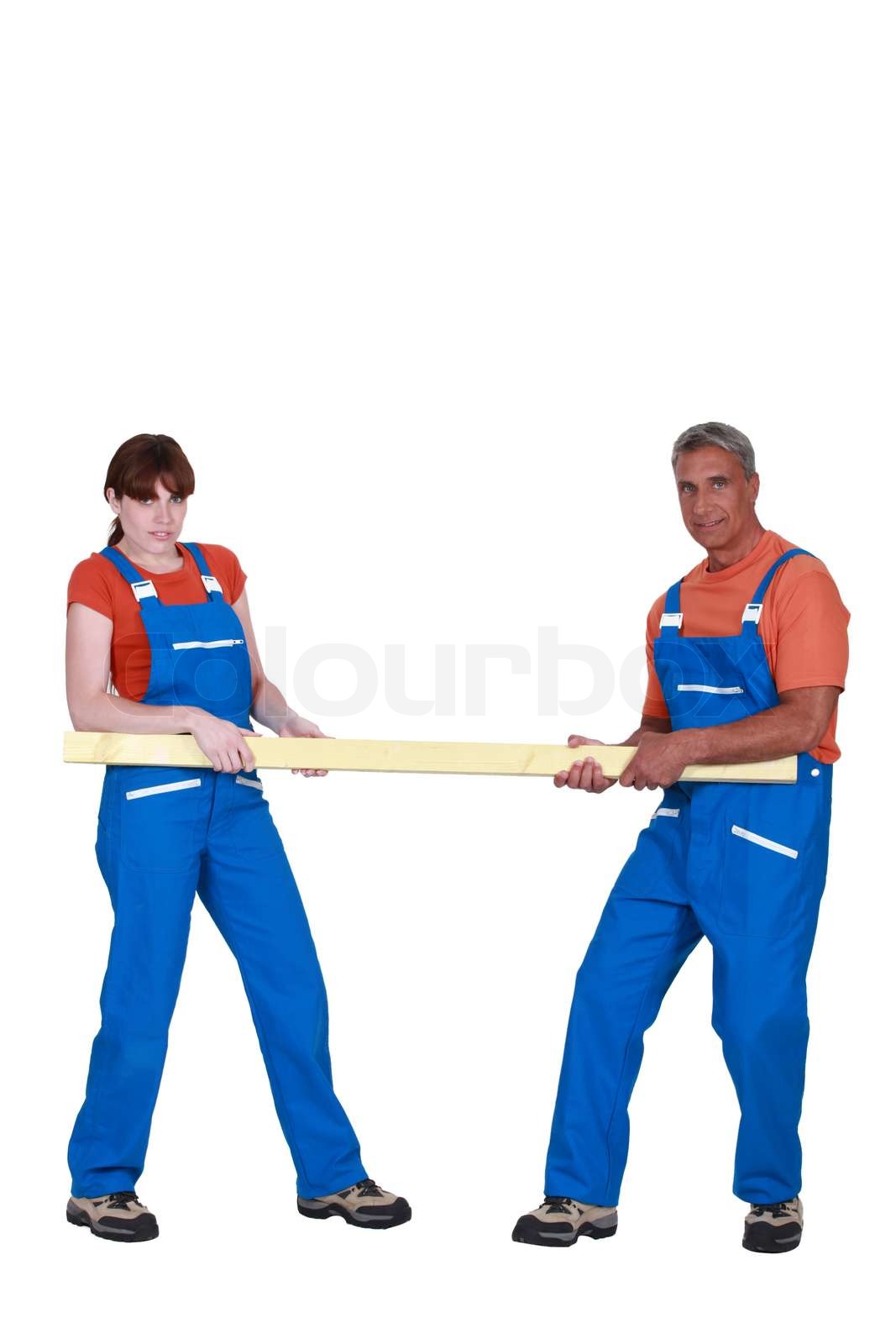 Construction workers pulling a piece of timber | Stock image | Colourbox