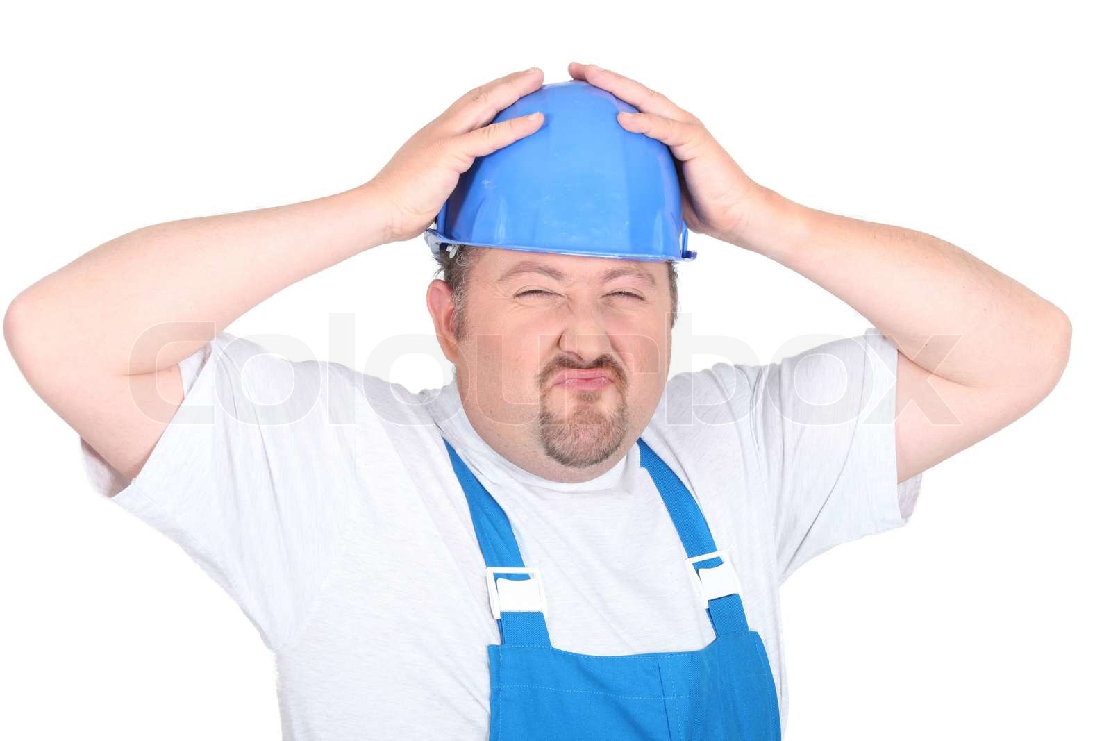 Construction worker scrunching his eyes | Stock image | Colourbox