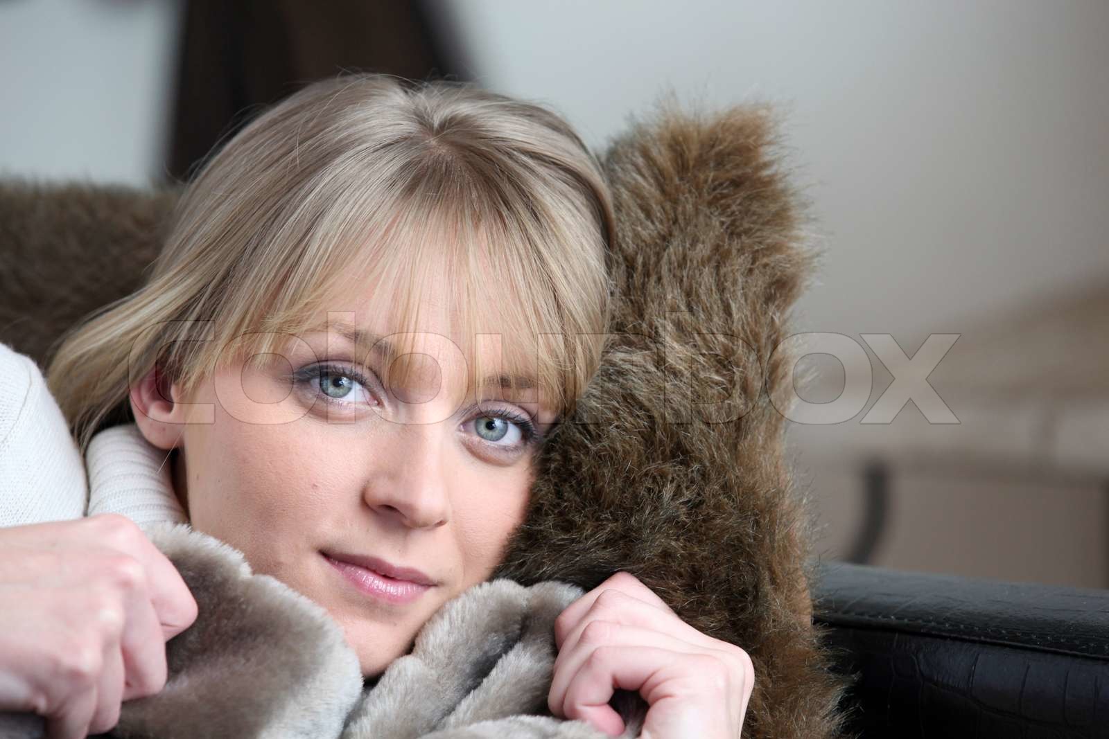 Woman snug on a sofa | Stock image | Colourbox