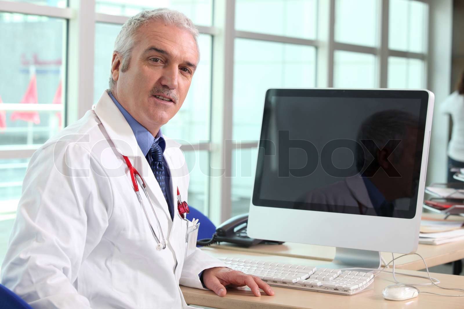 doctor at his desk | Stock image | Colourbox