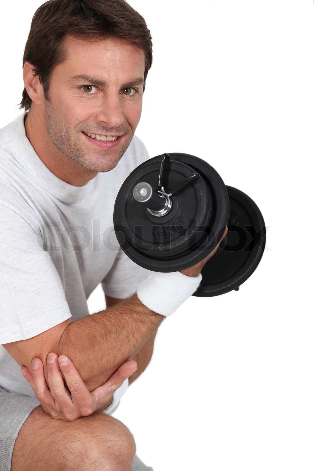 Man lifting weights | Stock image | Colourbox