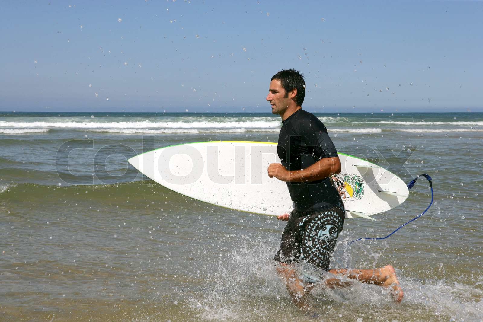 surfer in profile running | Stock image | Colourbox