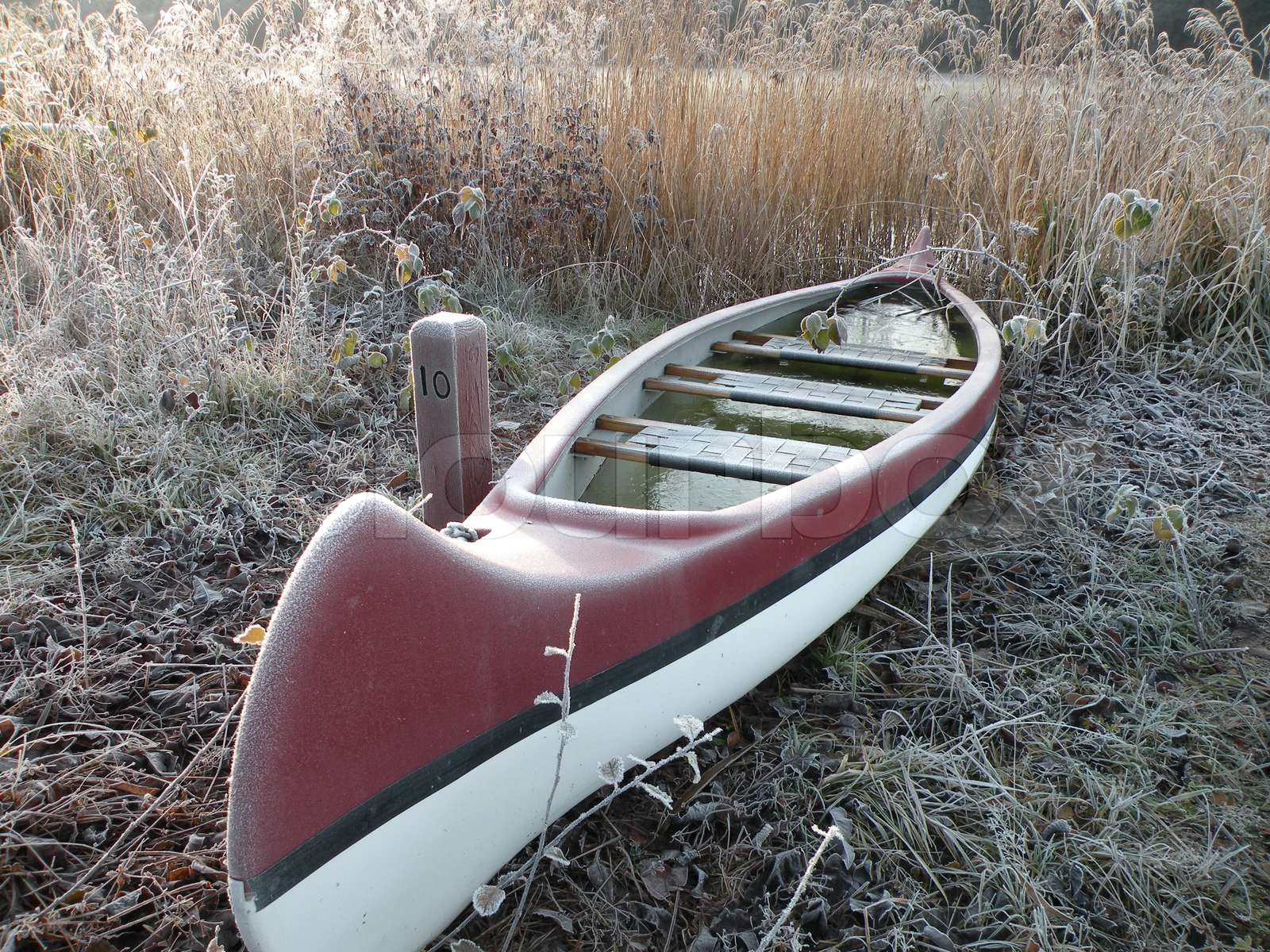 canoe with frozen water inside | Stock image | Colourbox