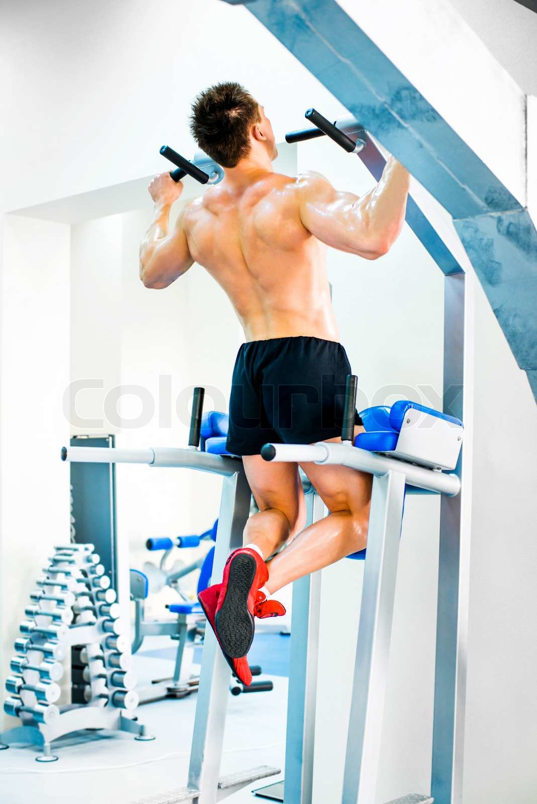 bodybuilder doing exercises on the horizontal bar | Stock image | Colourbox