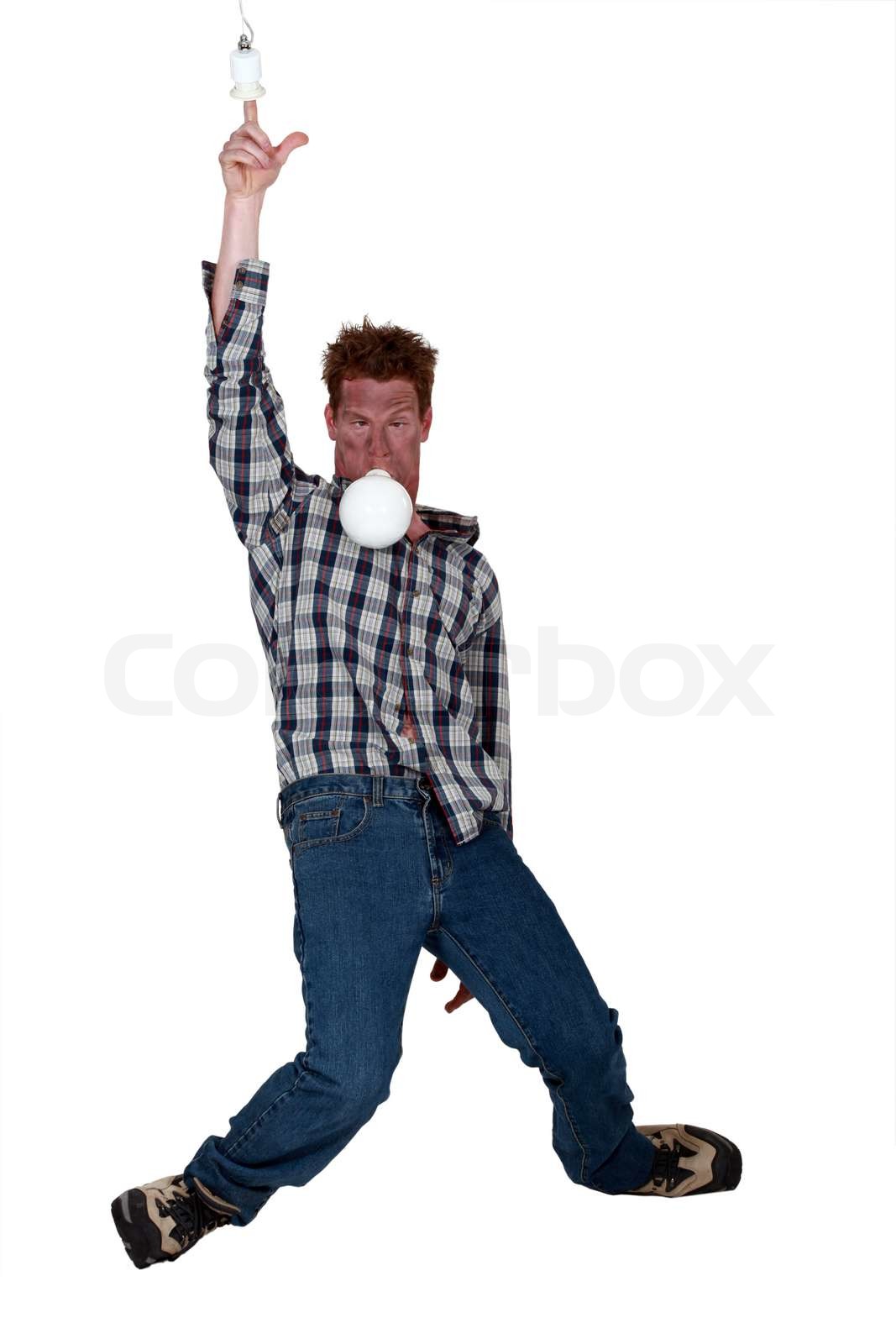 Man putting finger in electrical socket | Stock image | Colourbox