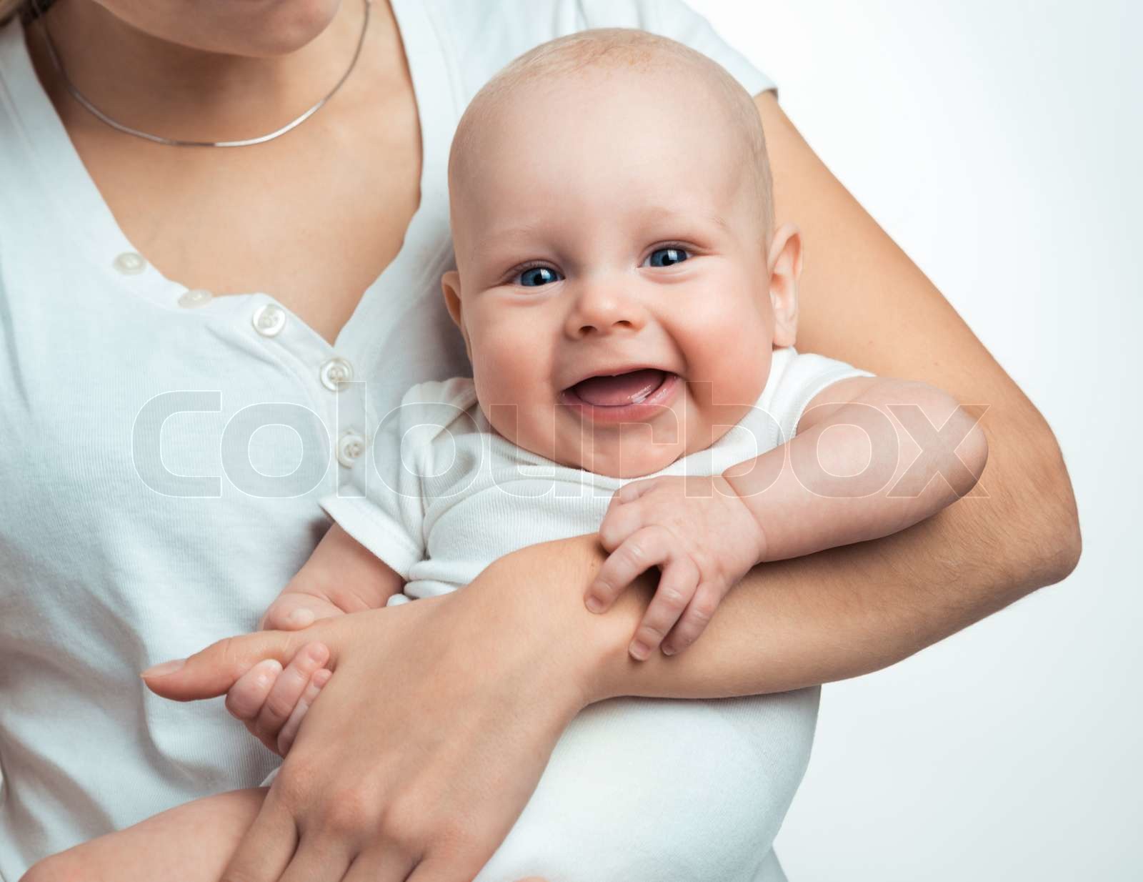 baby boy in the comfort of moms arms | Stock image | Colourbox