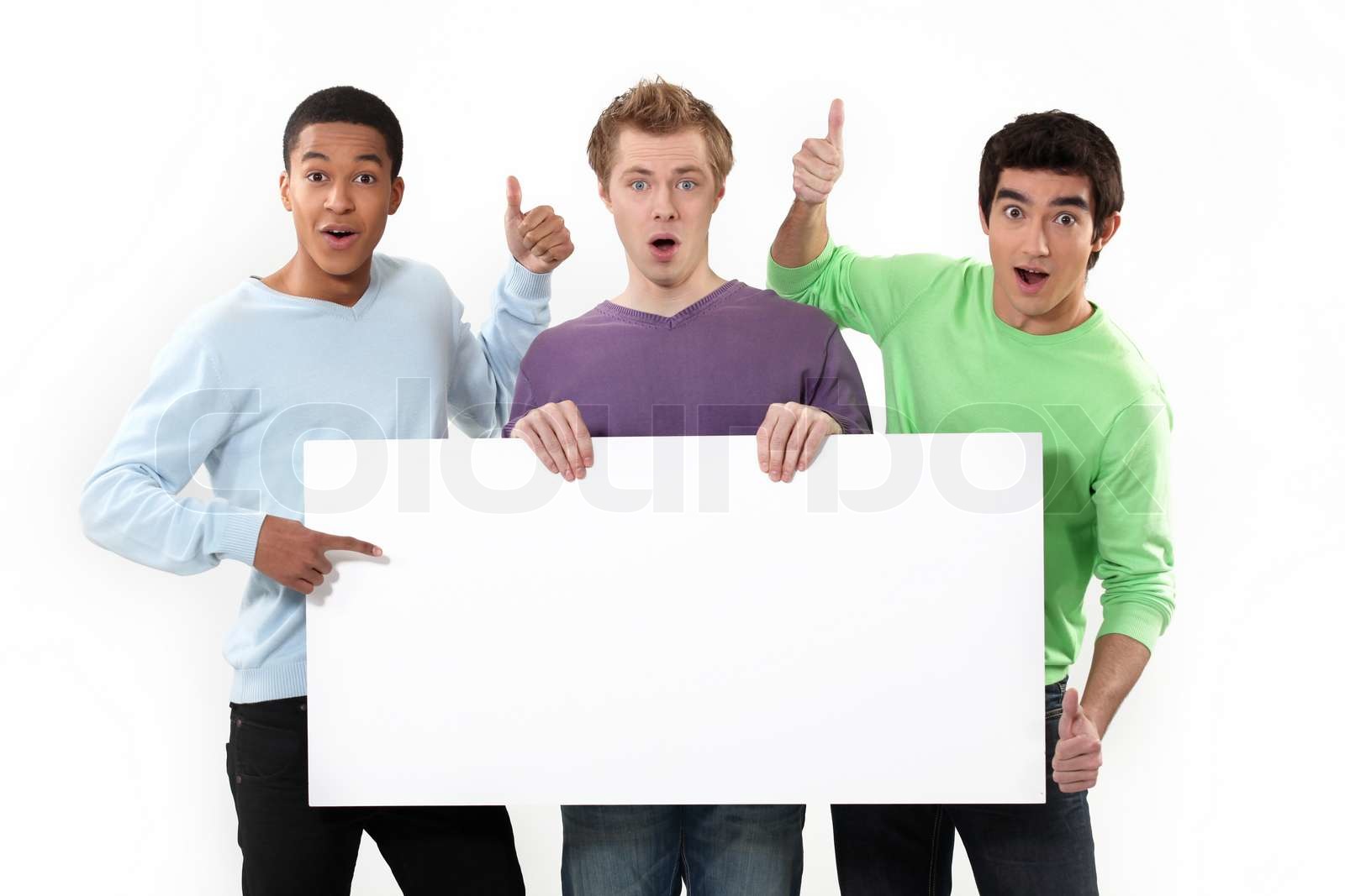 Expressive men holding a white sign for message | Stock image | Colourbox