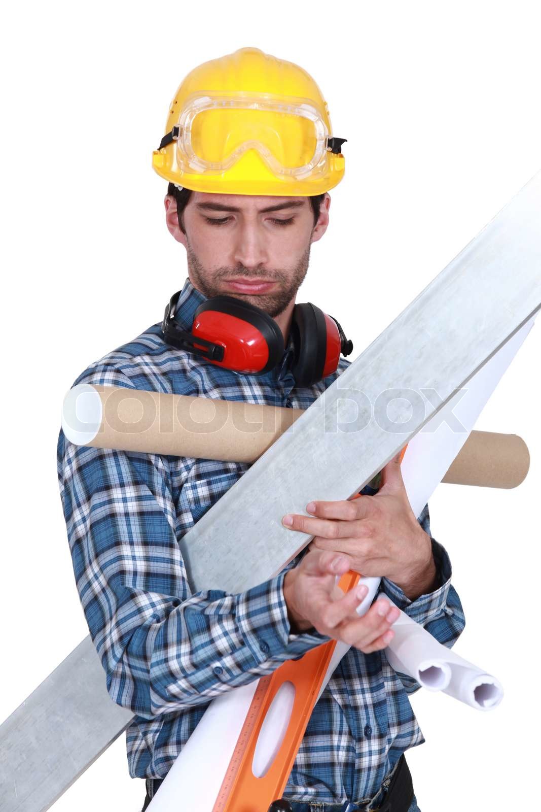 Construction worker overloaded with tools and building materials ...