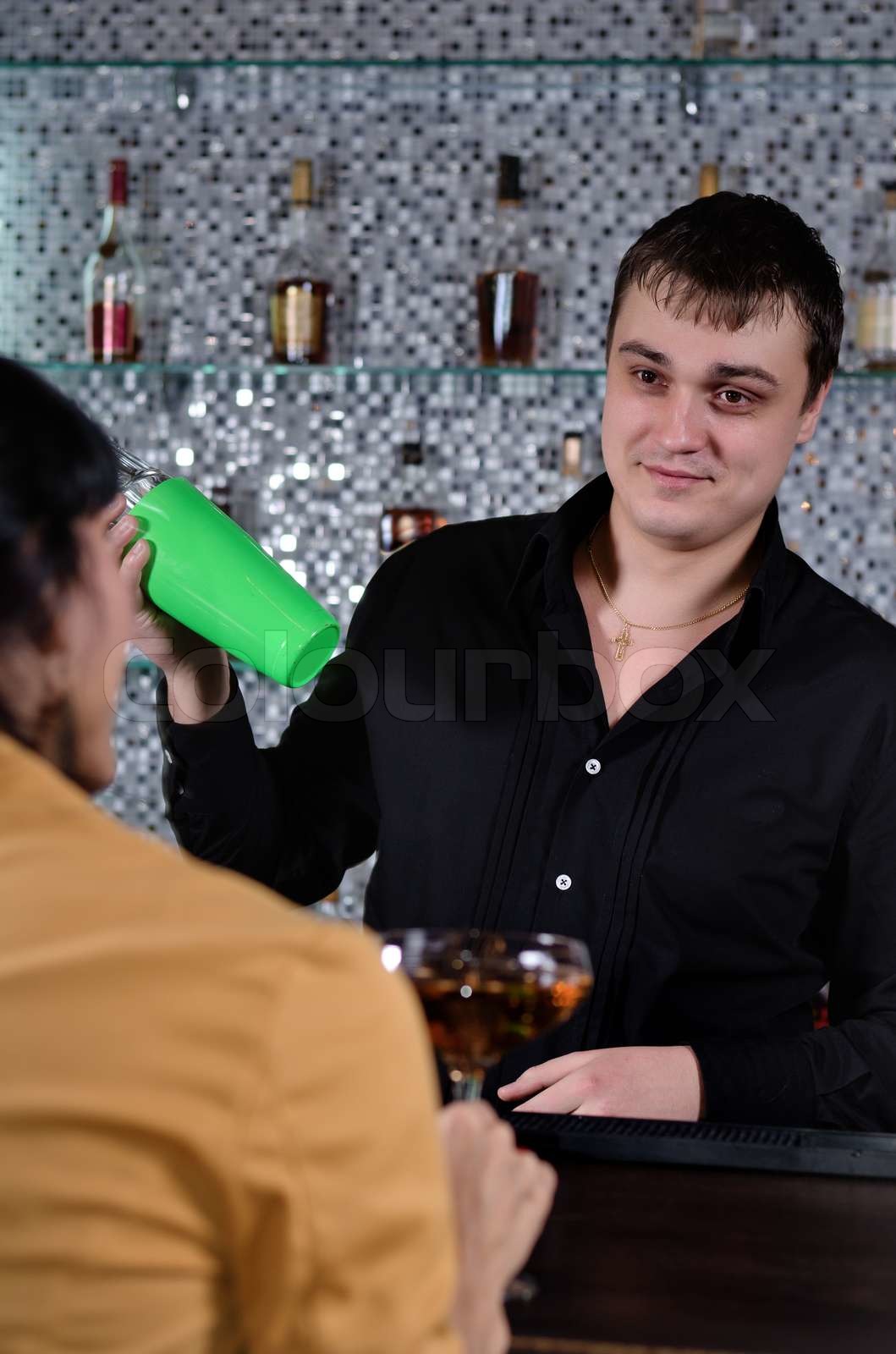 Woman sitting at a bar waiting to be served | Stock image | Colourbox