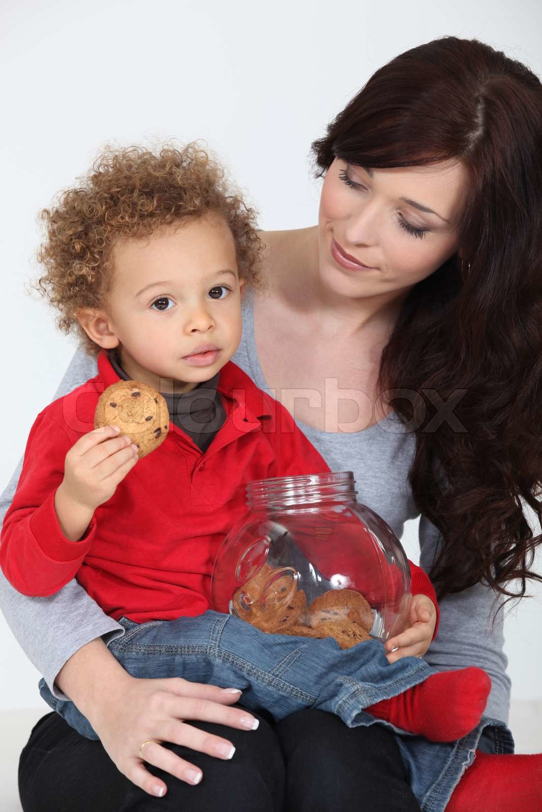 Cute child eating cookies | Stock image | Colourbox