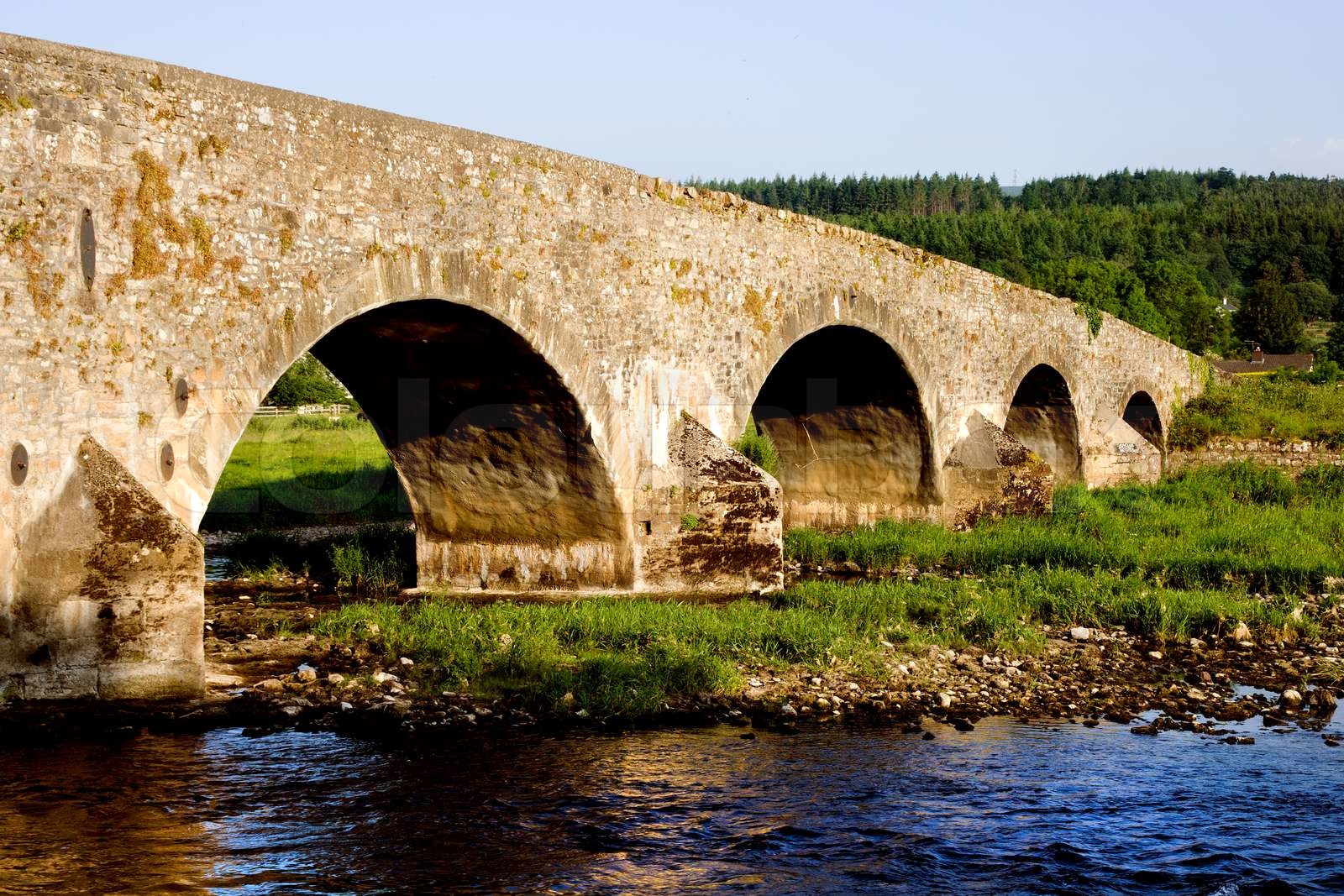 Picturesque scenery by the old bridge across the Suir river in county ...