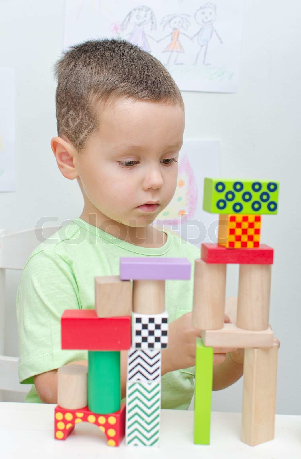 Boy playing with blocks in kindergarten | Stock image | Colourbox