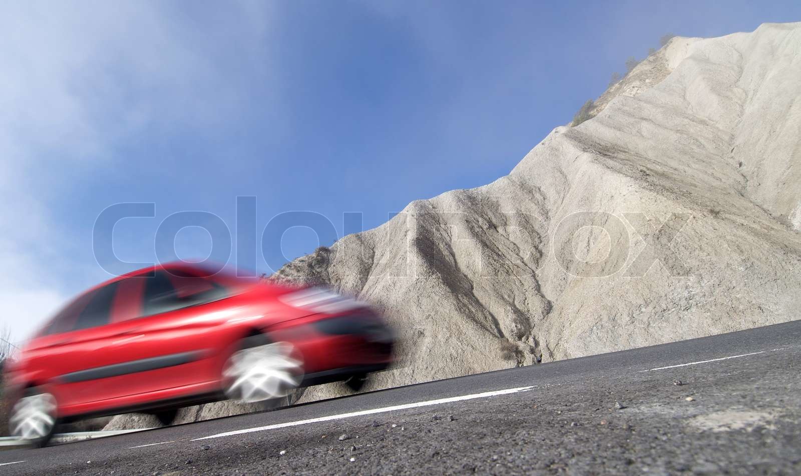 Red car on a road | Stock image | Colourbox