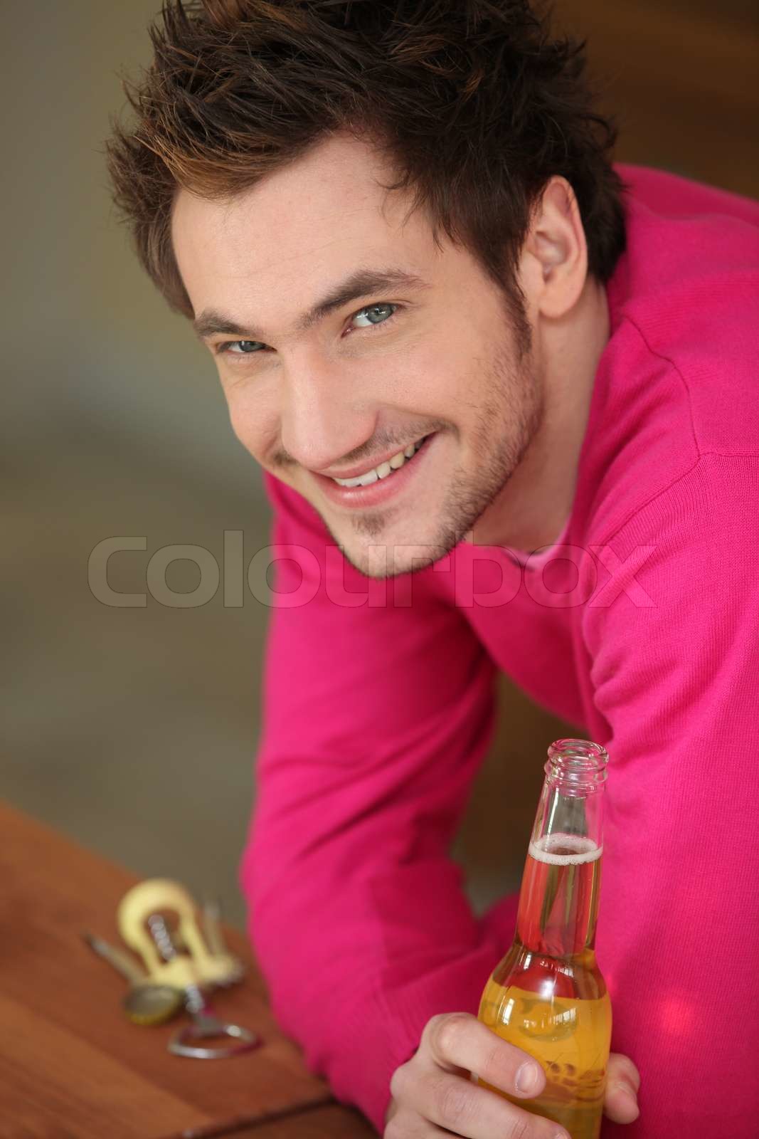 Smiling boy drinking beer | Stock image | Colourbox