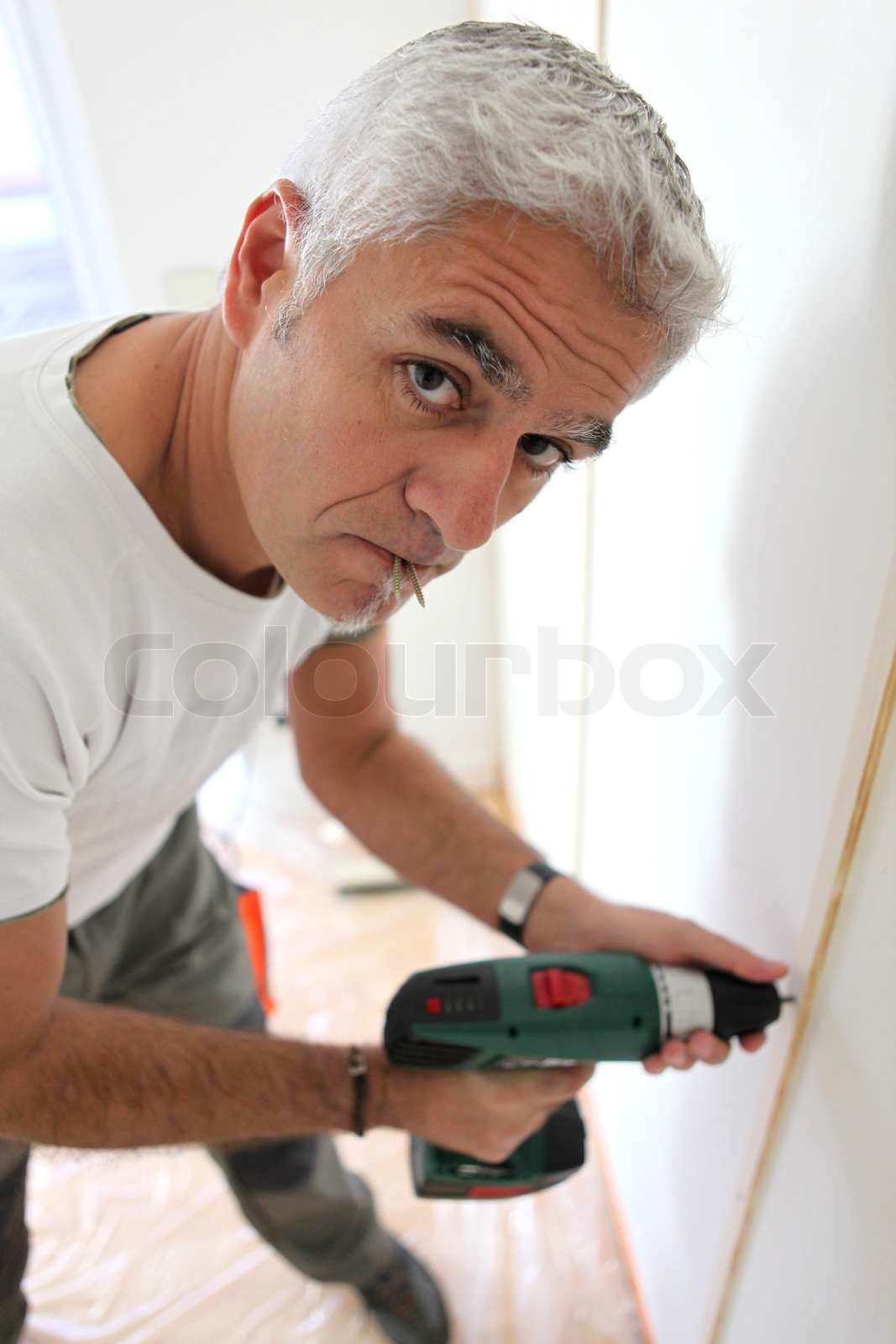 Man using an cordless screwdriver | Stock image | Colourbox