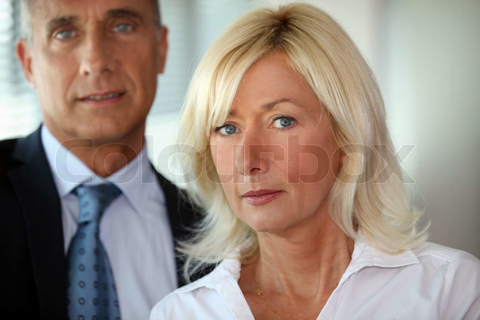 A secretary posing with her boss | Stock image | Colourbox