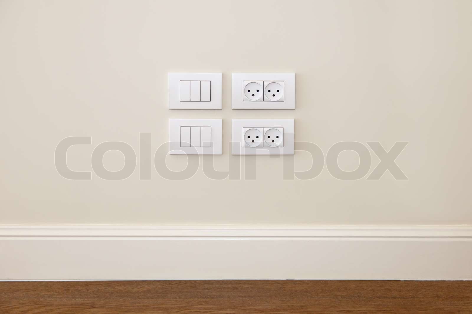 Power outlet and light switch on the wall | Stock image | Colourbox