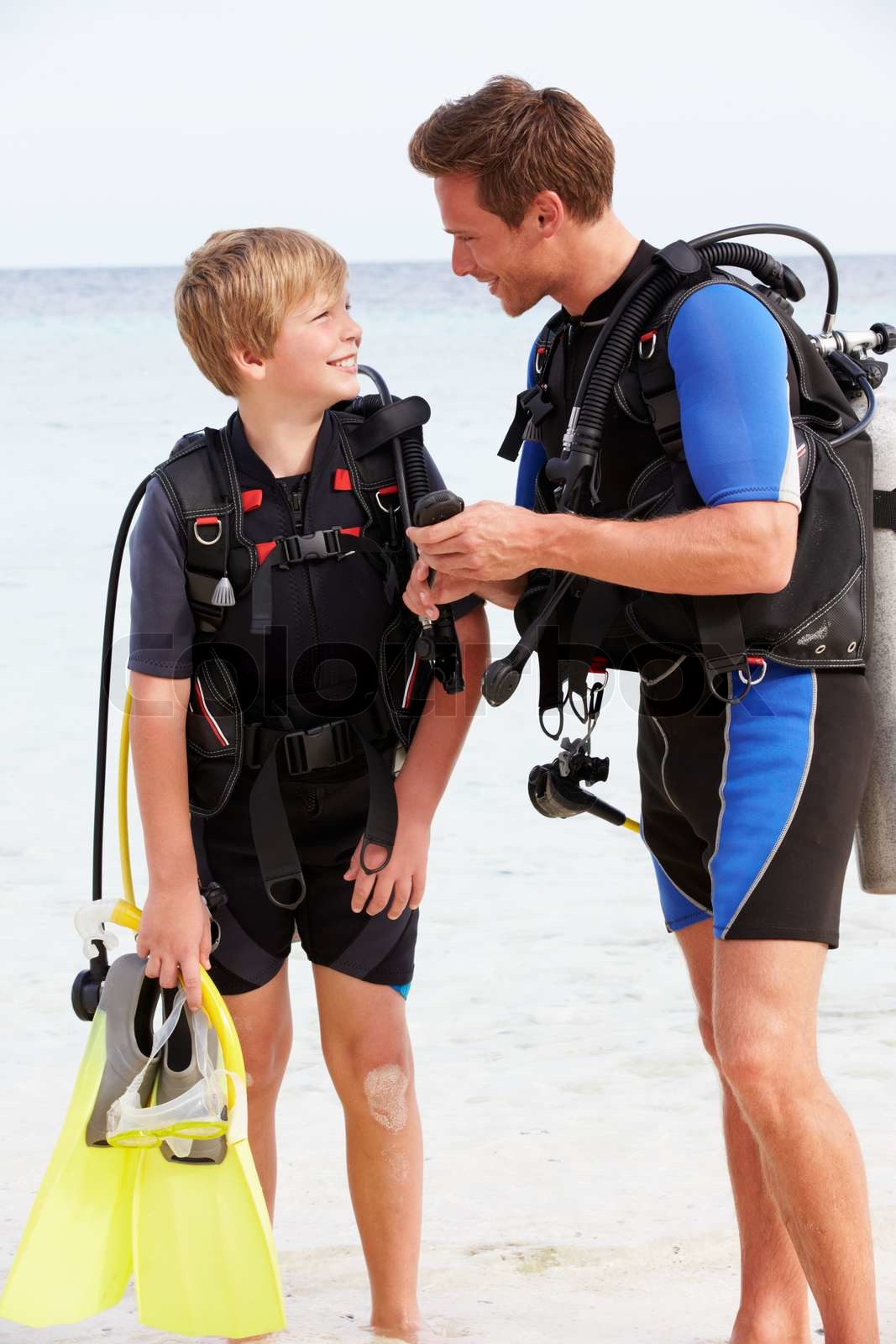 Father And Son With Scuba Diving Equipment On Beach Holiday | Stock ...