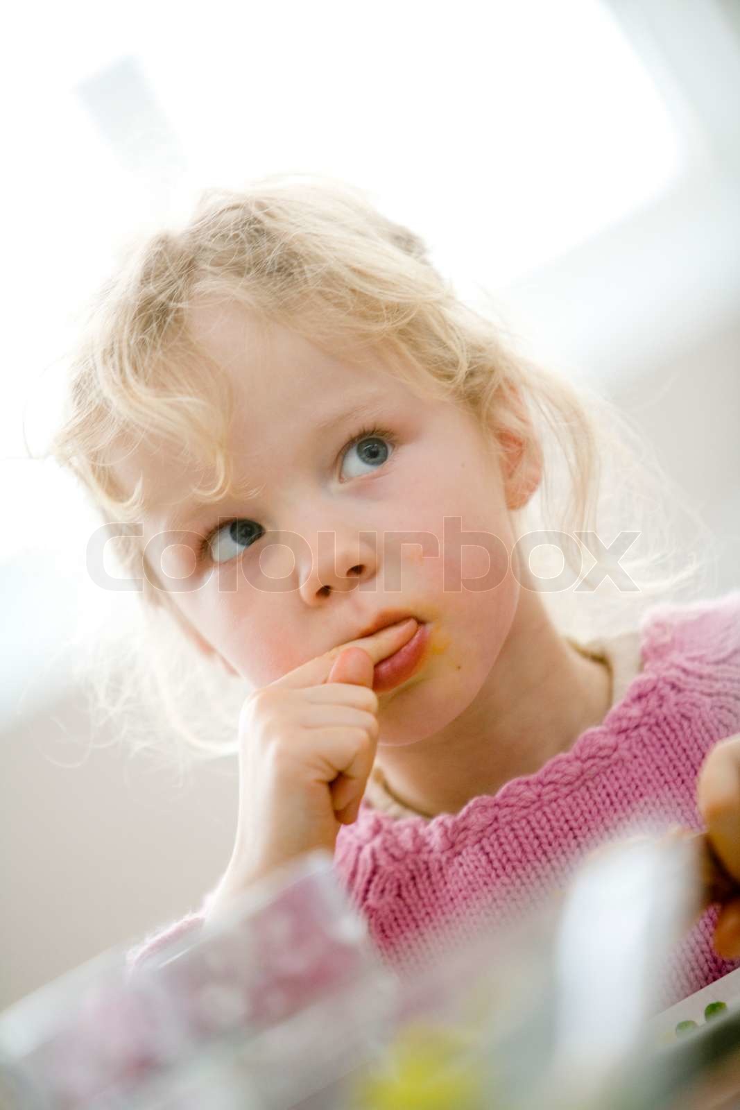 A young caucasian girl eating her dinner | Stock image | Colourbox