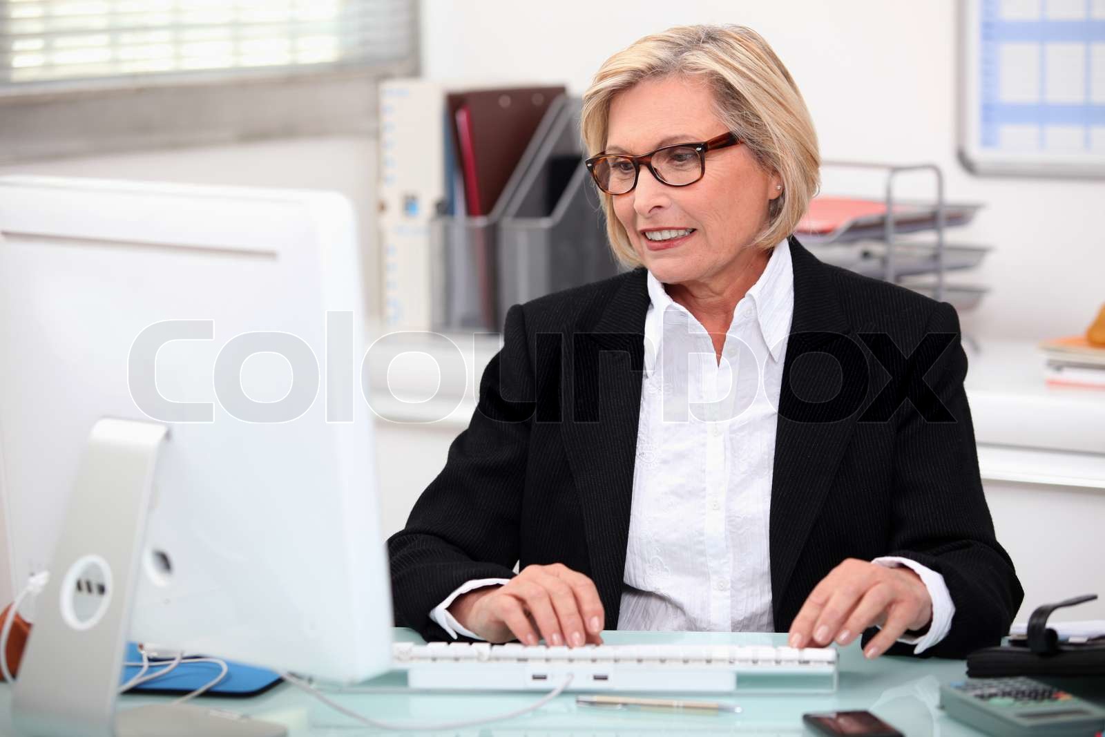 Senior secretary at work | Stock image | Colourbox