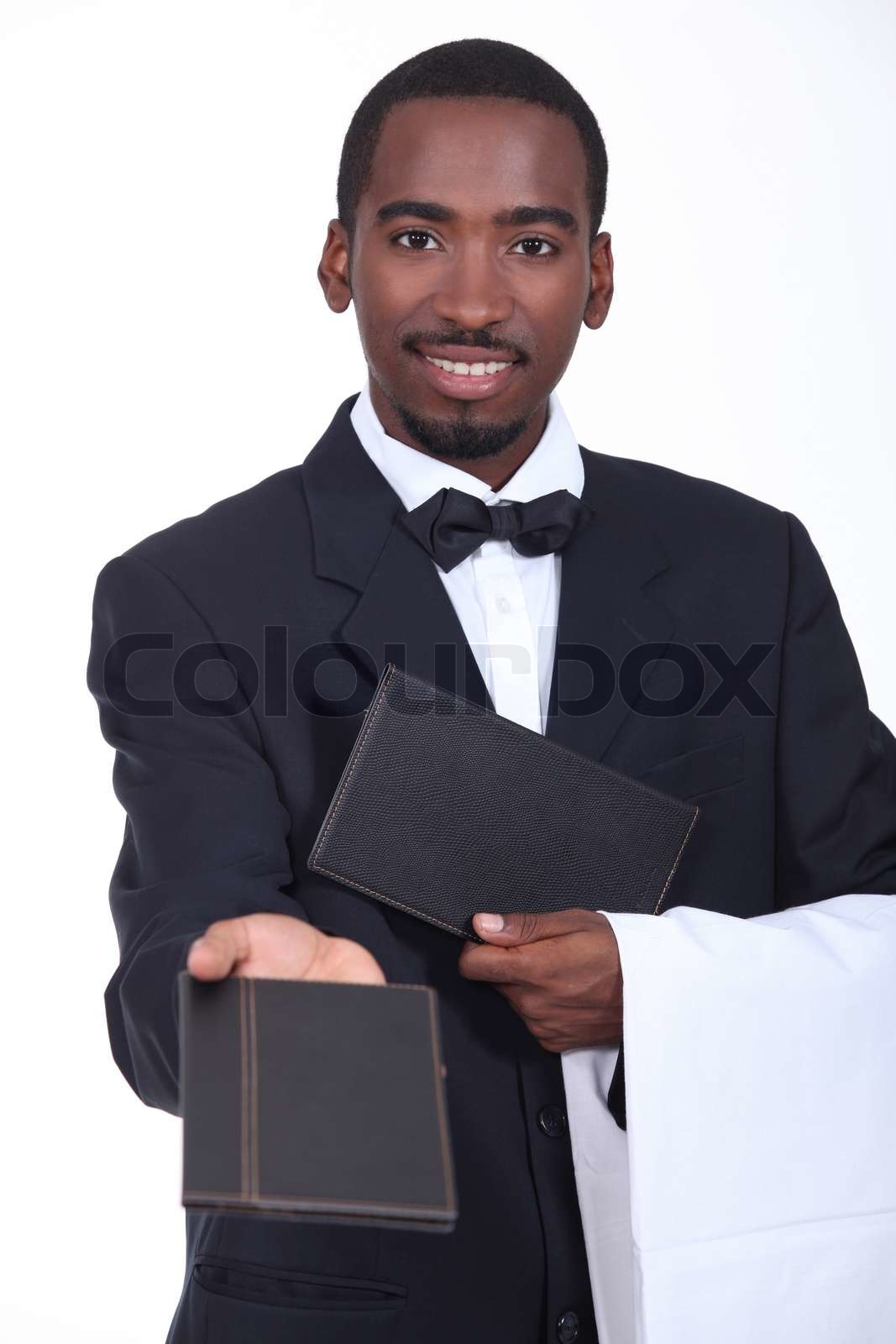 Waiter offering a menu | Stock image | Colourbox