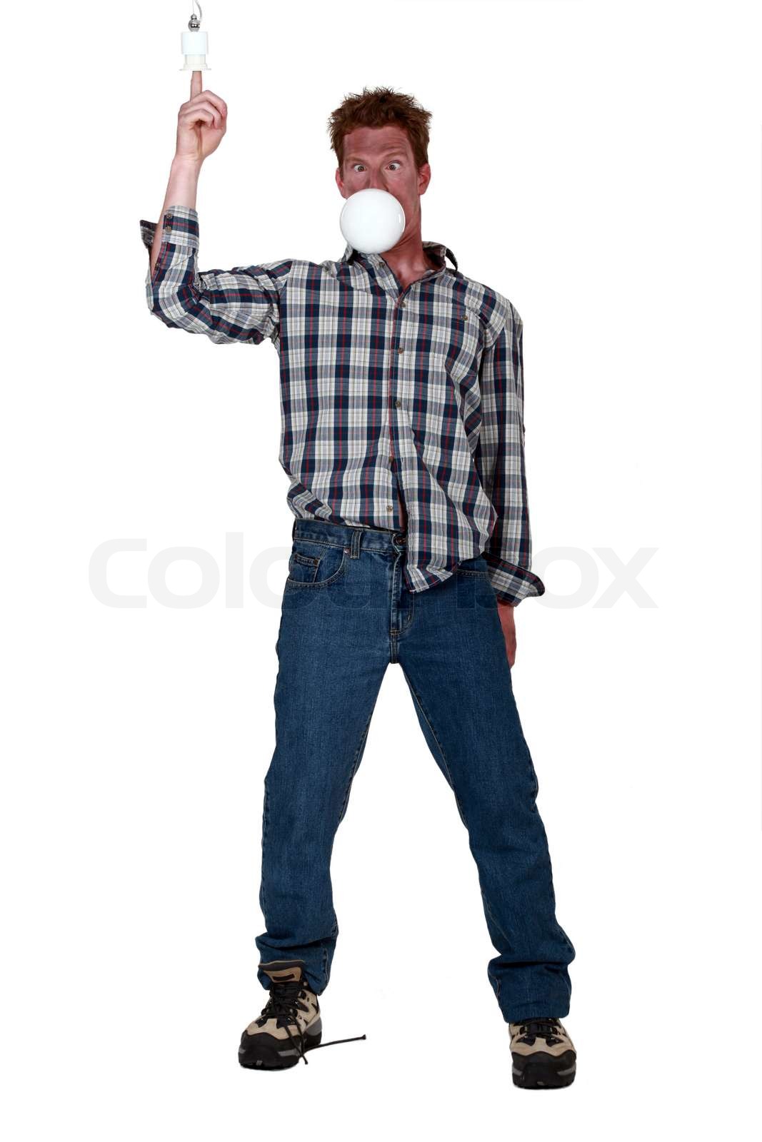 Man with his finger in a light socket | Stock image | Colourbox