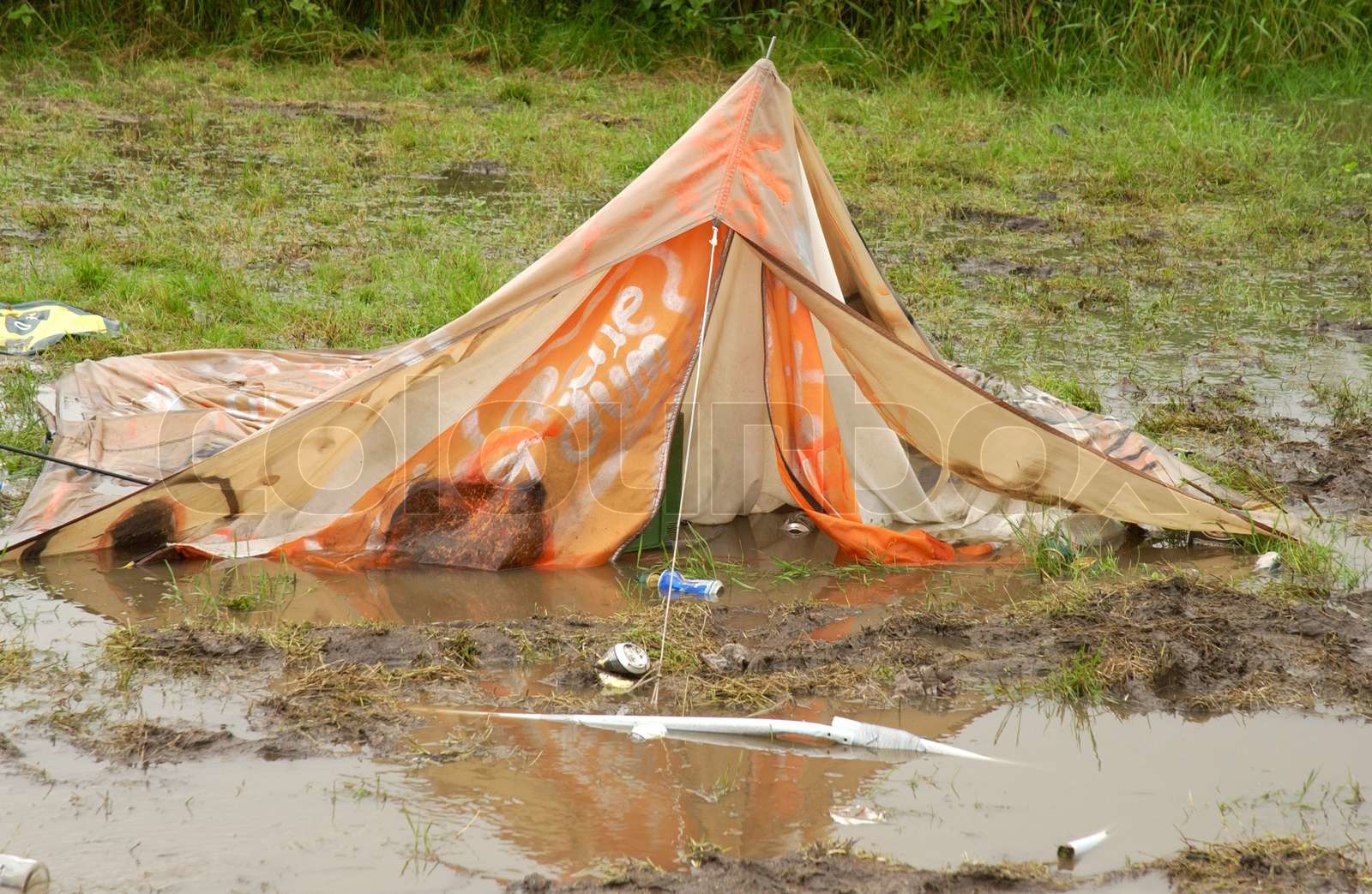Destroyed tent and rubbish on muddy ground | Stock image | Colourbox