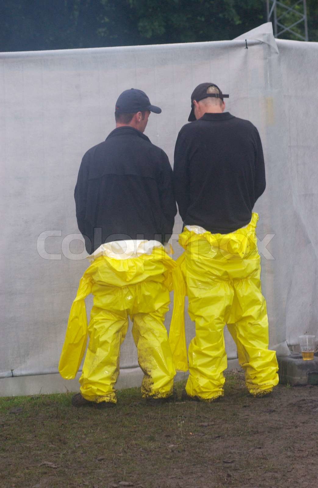 Back of two construction workers peeing | Stock image | Colourbox