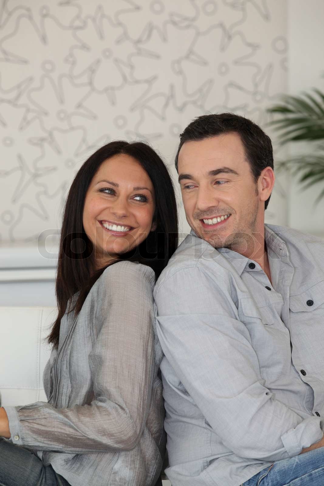 Couple sitting back to back | Stock image | Colourbox